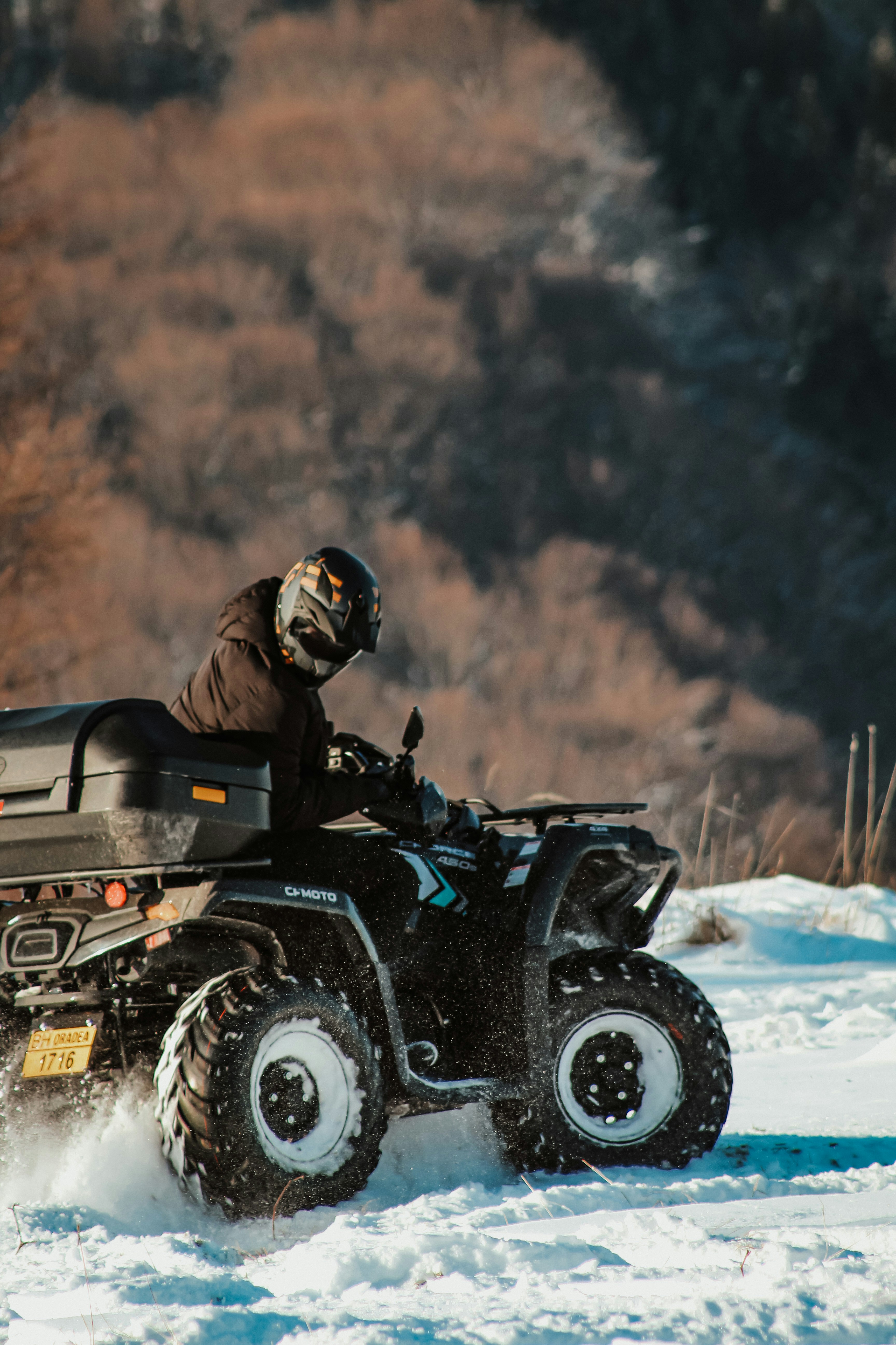 Powder Crest: Rider Conquers Snow on a Rugged ATV