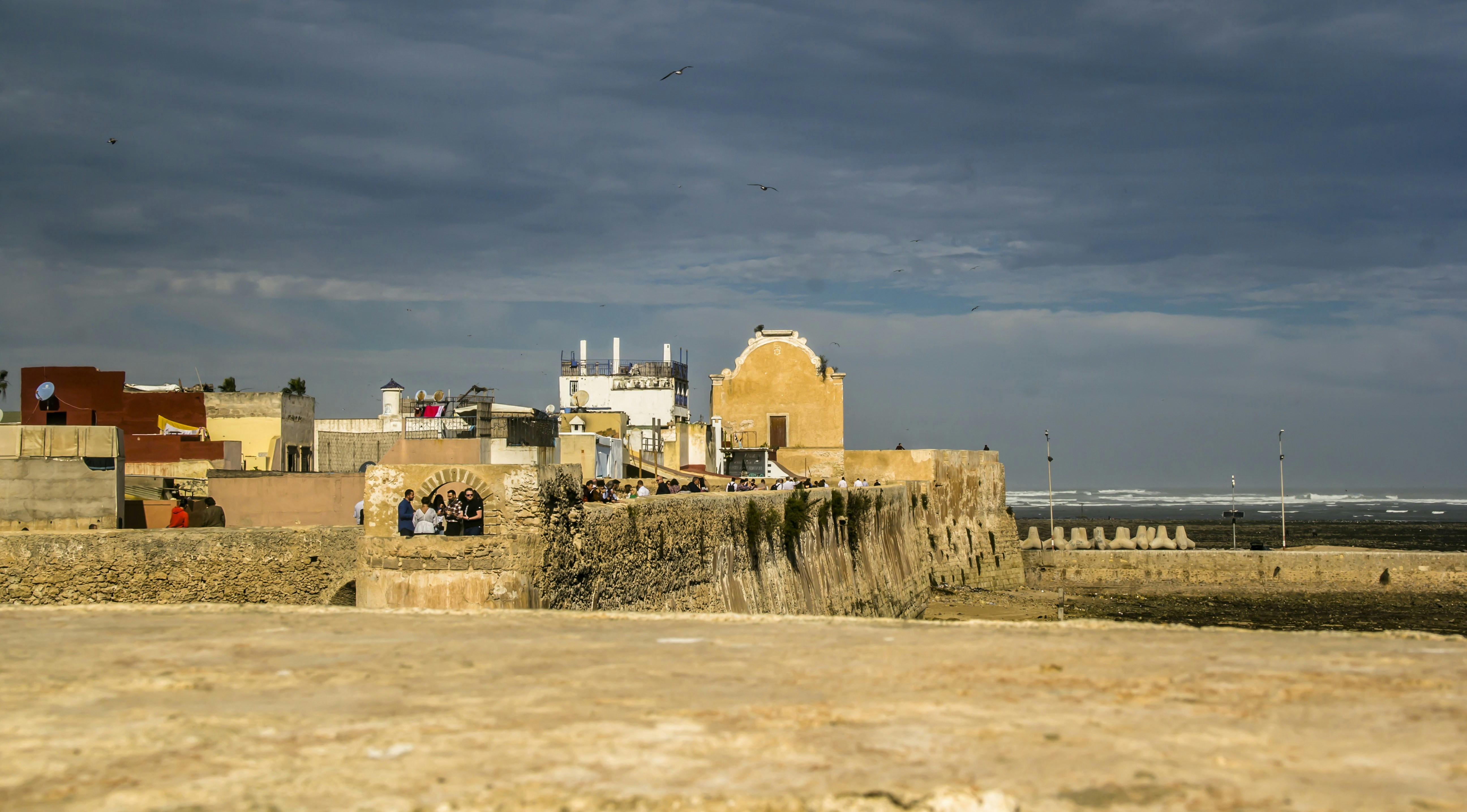 Sunlit Bastion Along a Weathered Sea Wall