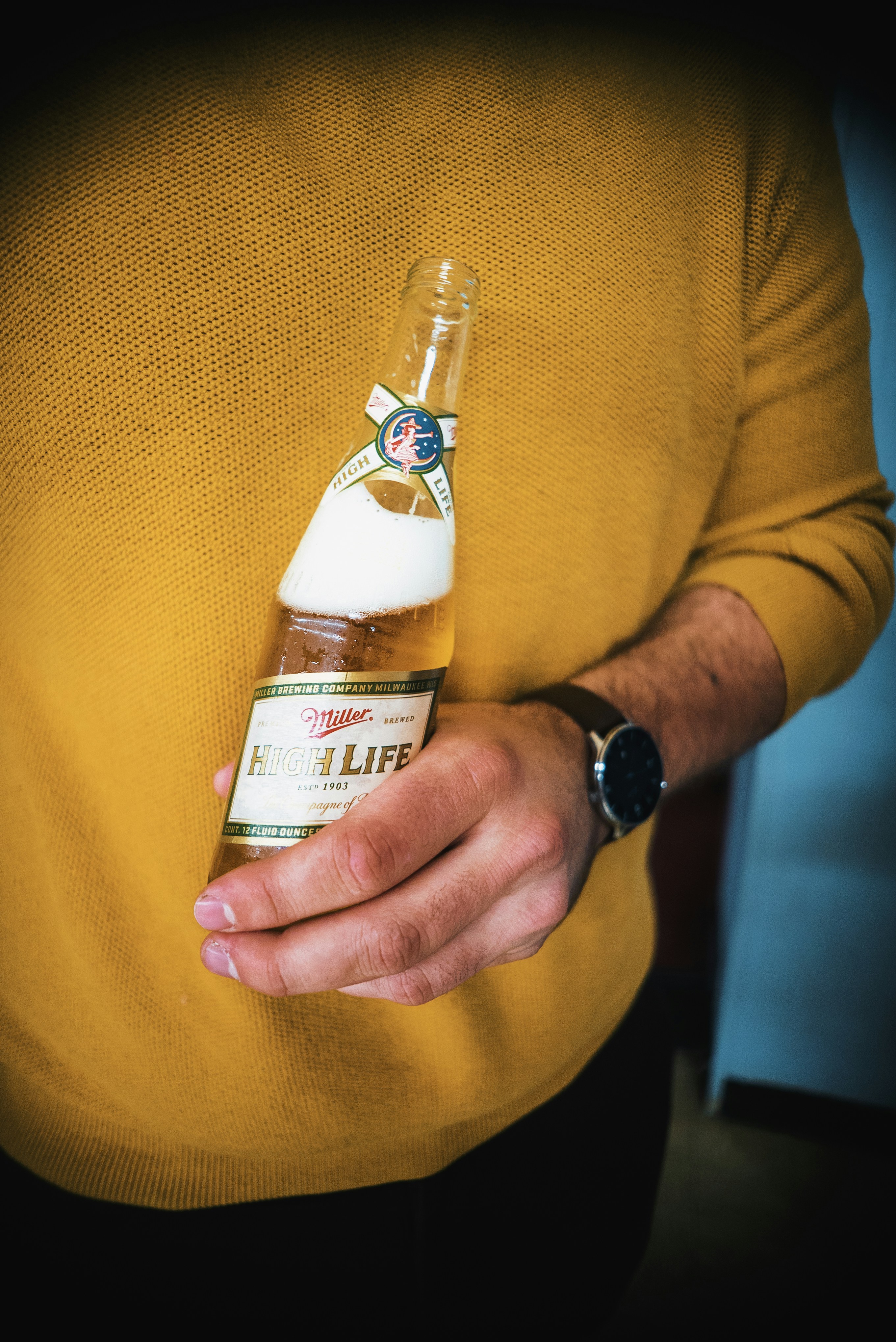 Bottle of High Life Gripped by a Golden Knit