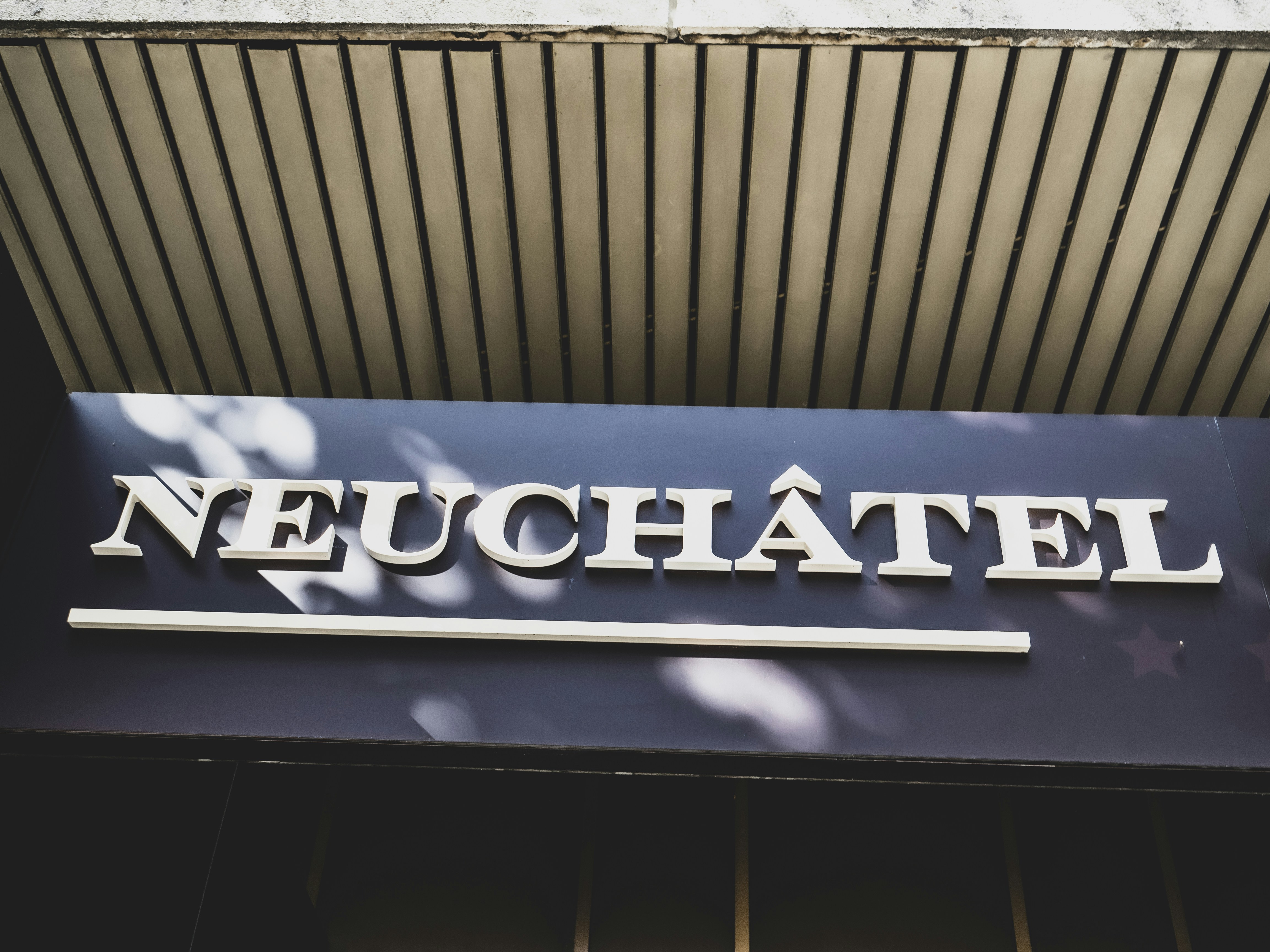 A sign on a building photo – Free Neuchâtel Image on Unsplash