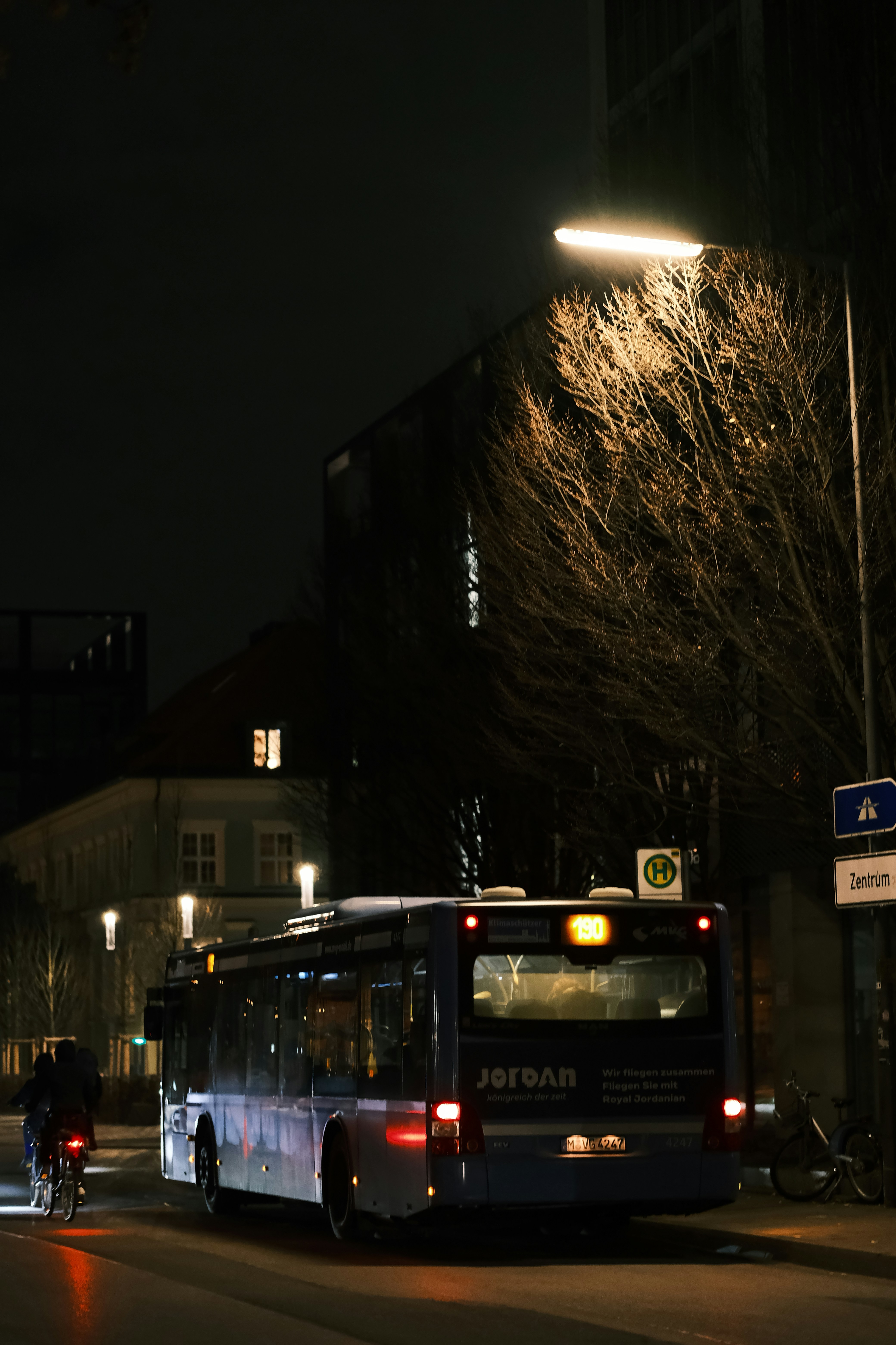 Nocturnal City Bus Under Amber Streetlights