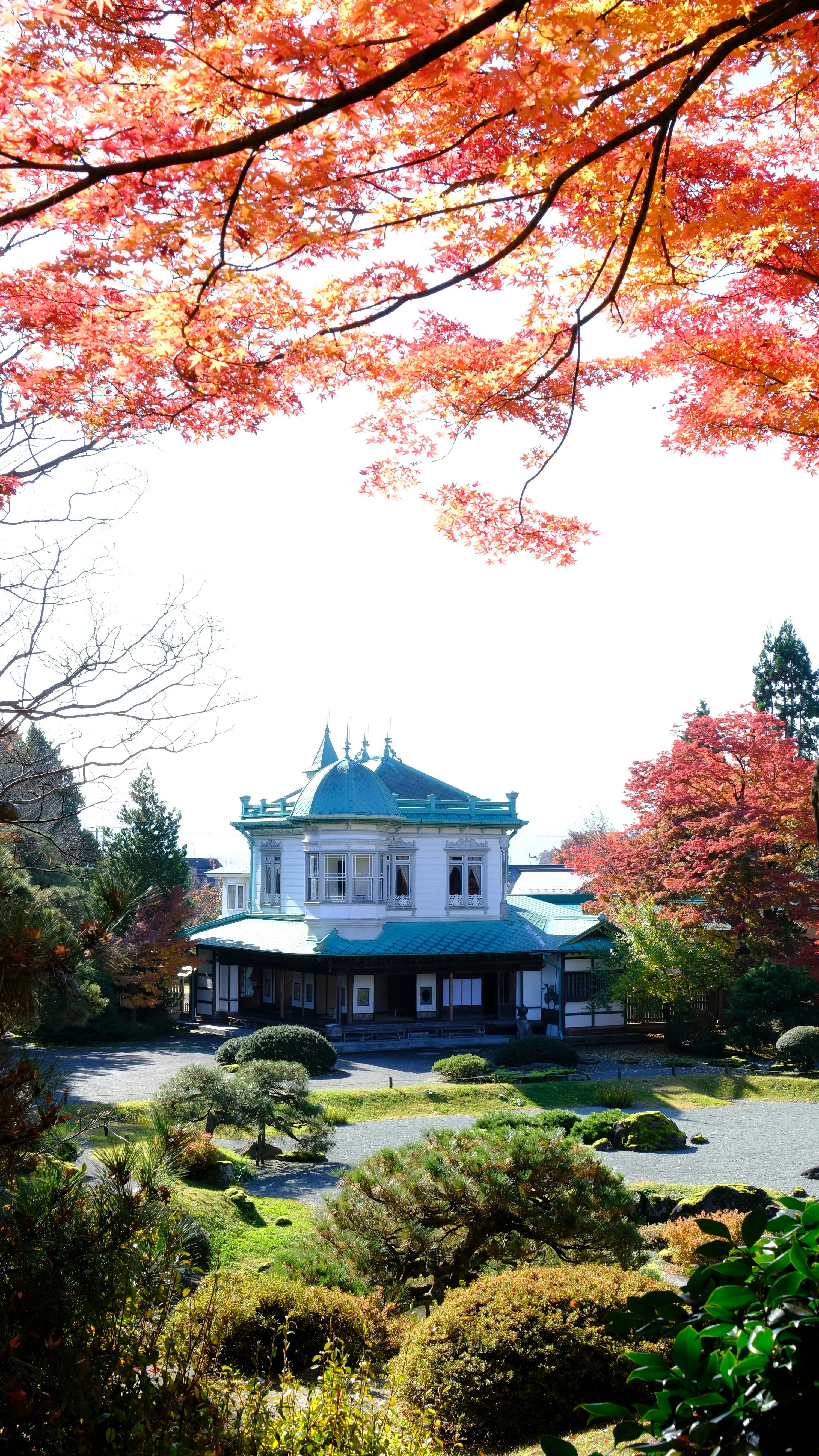 Crimson Canopy Over a Quiet Japanese Teahouse in Autumn Garden