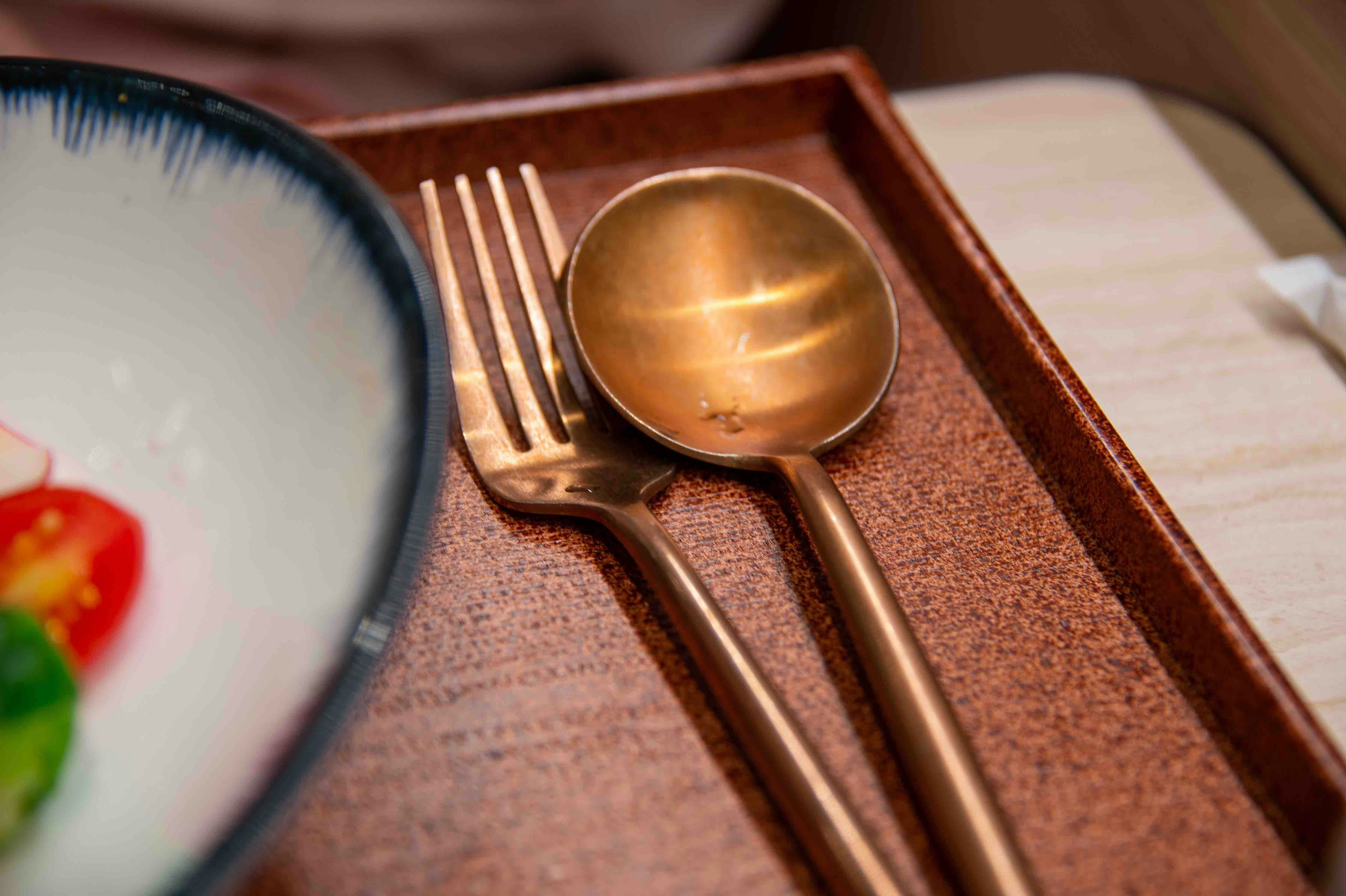 Copper Spoon on a Textured Tray: A Quiet Kitchen Moment