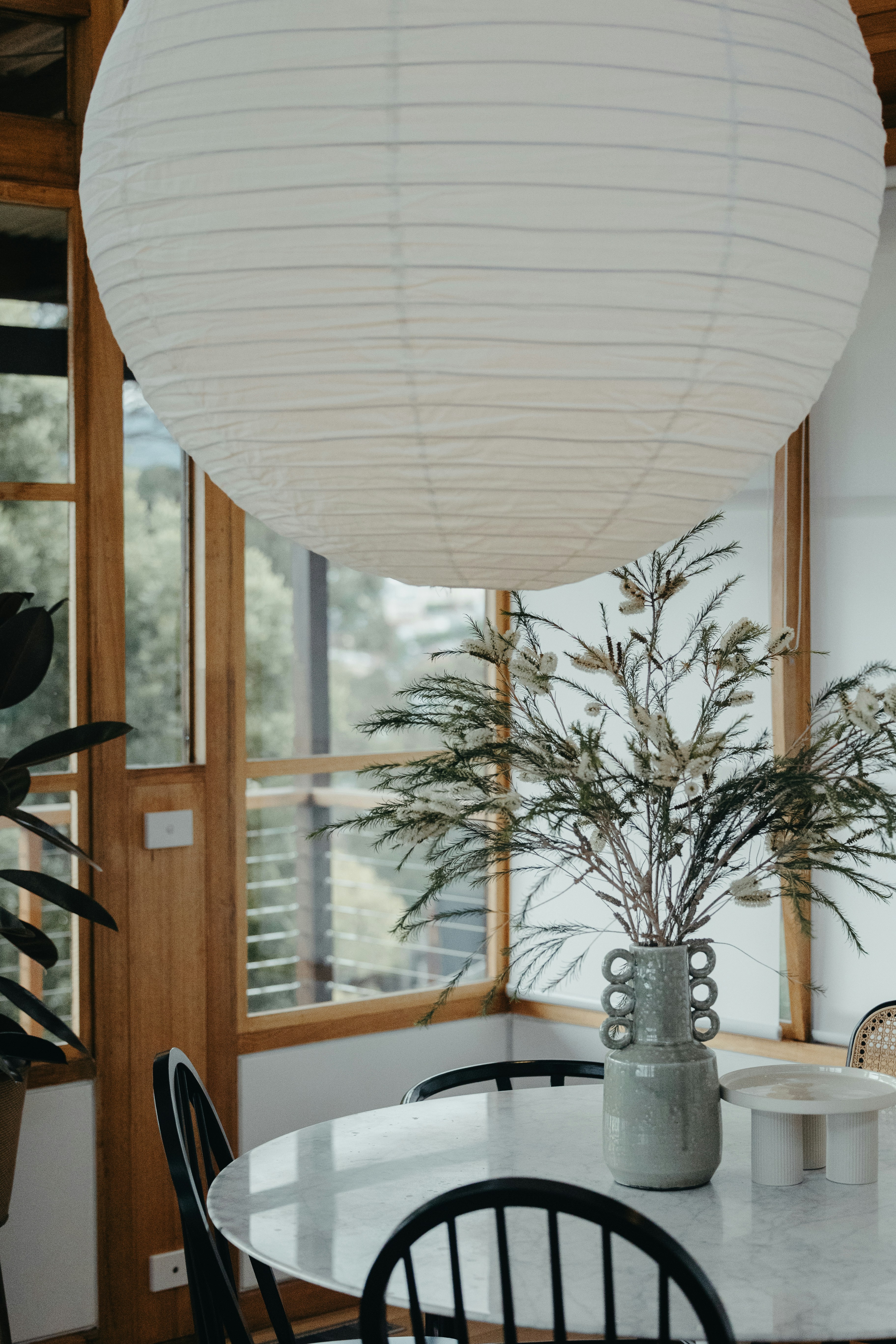 a table with a vase and chairs