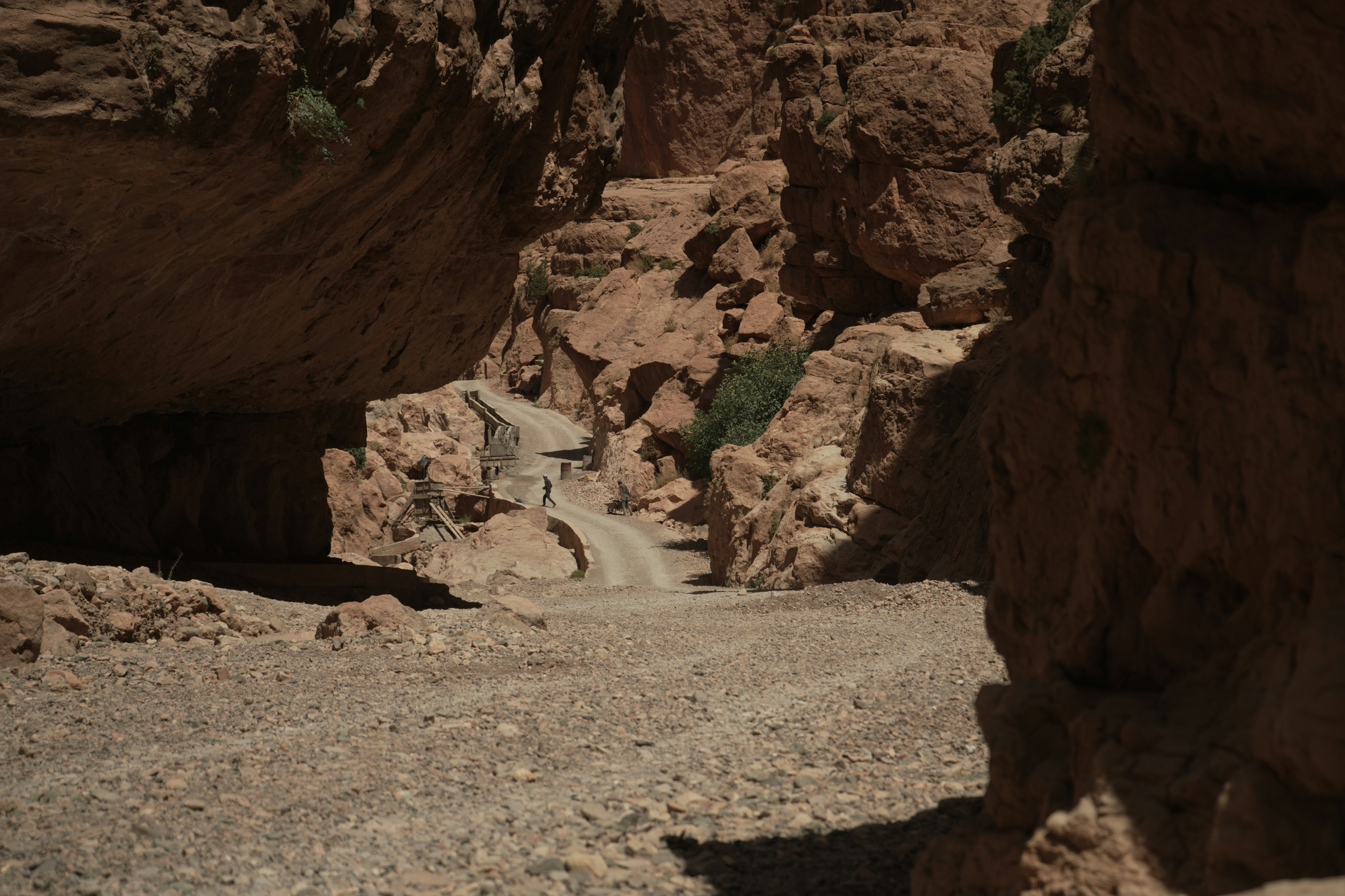 Echoes of Red Rock: A Narrow Canyon Path Winding Between Daylight and Shadow