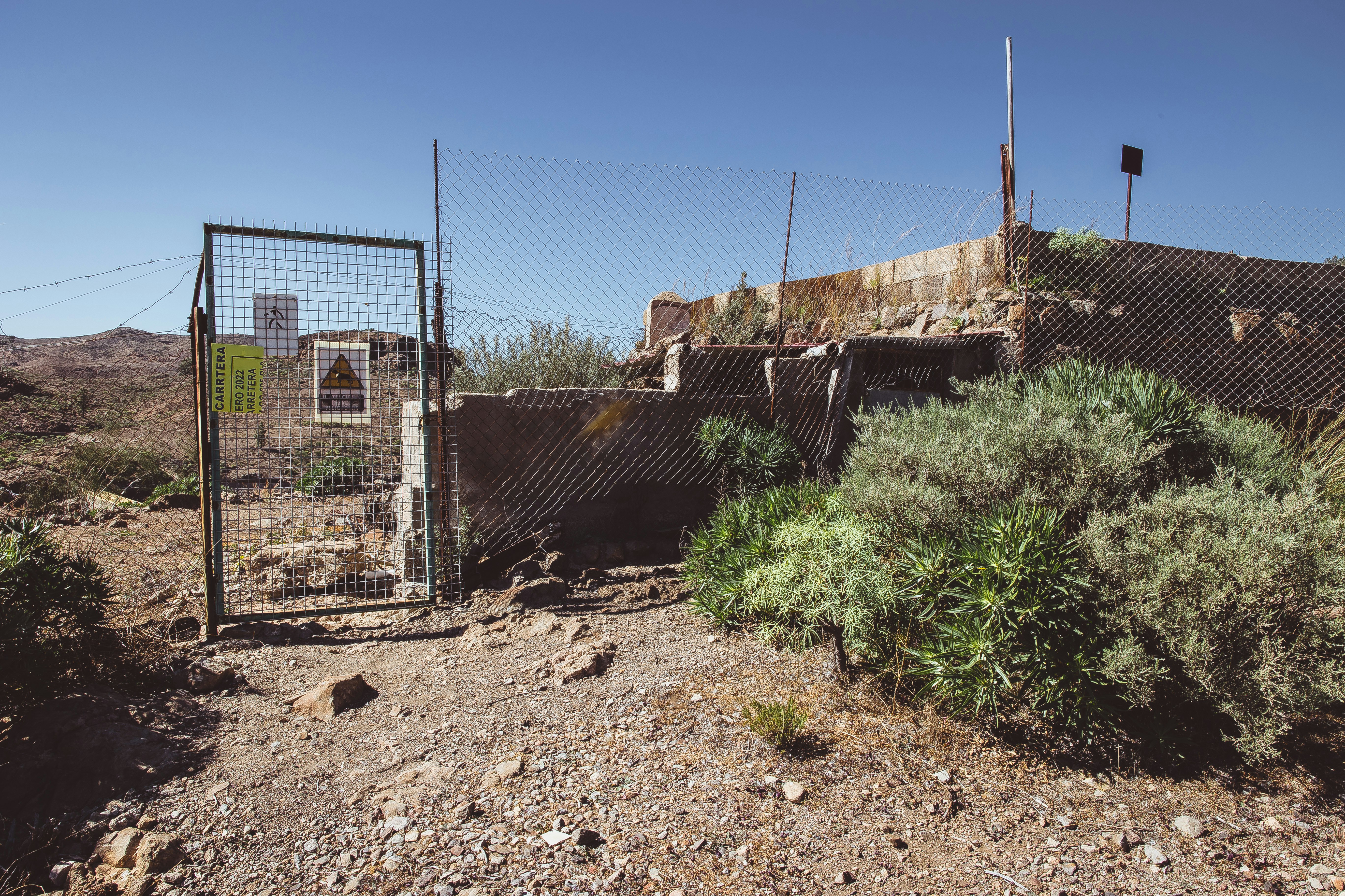 A fenced off area with a building in the background photo – Free Fence ...