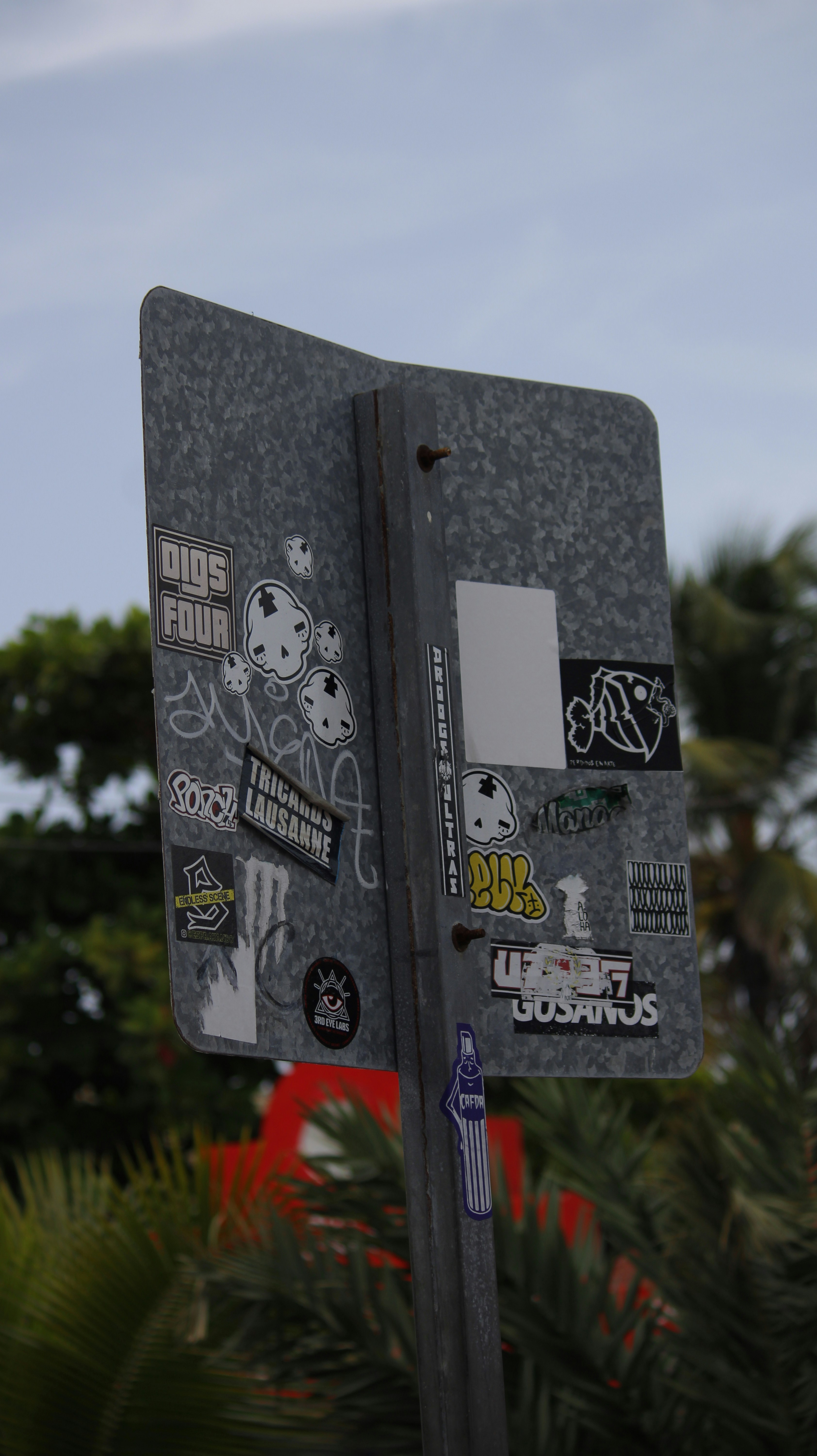 a parking meter with stickers on it