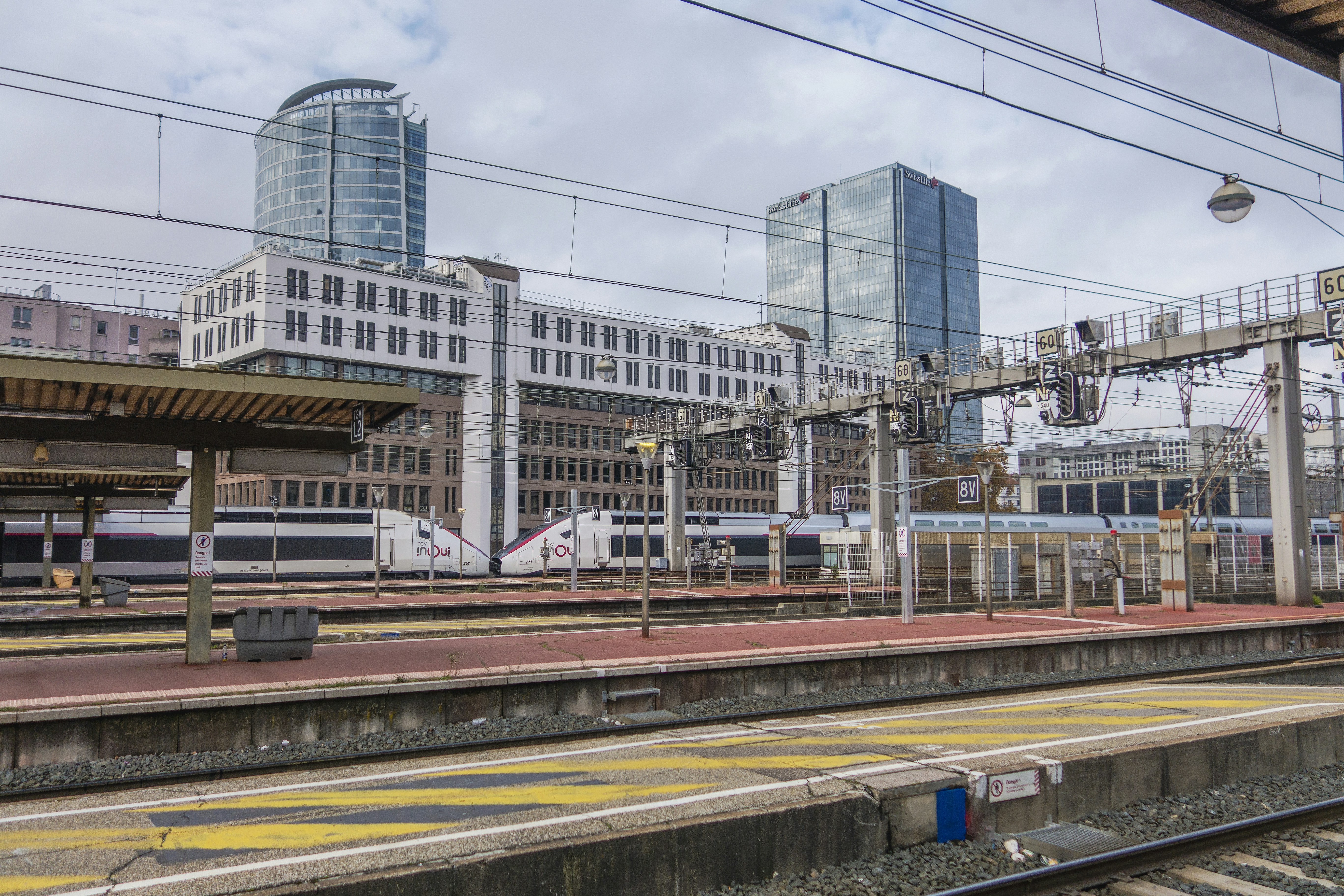 Glass Towers Over a Quiet Platform: Rails Framing a Modern City