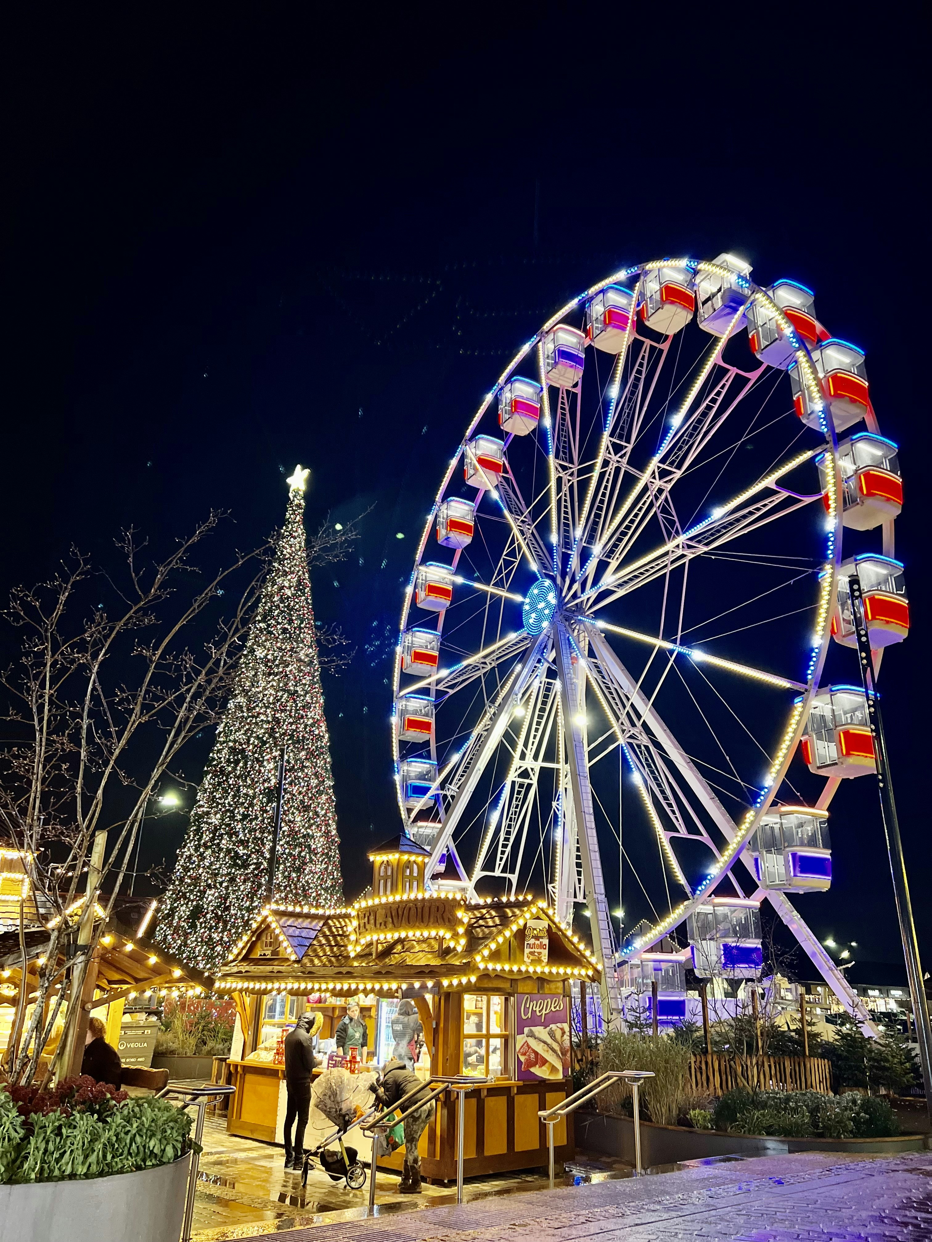 Night Carousel: A Glowing Ferris Wheel Behind a Festive Market