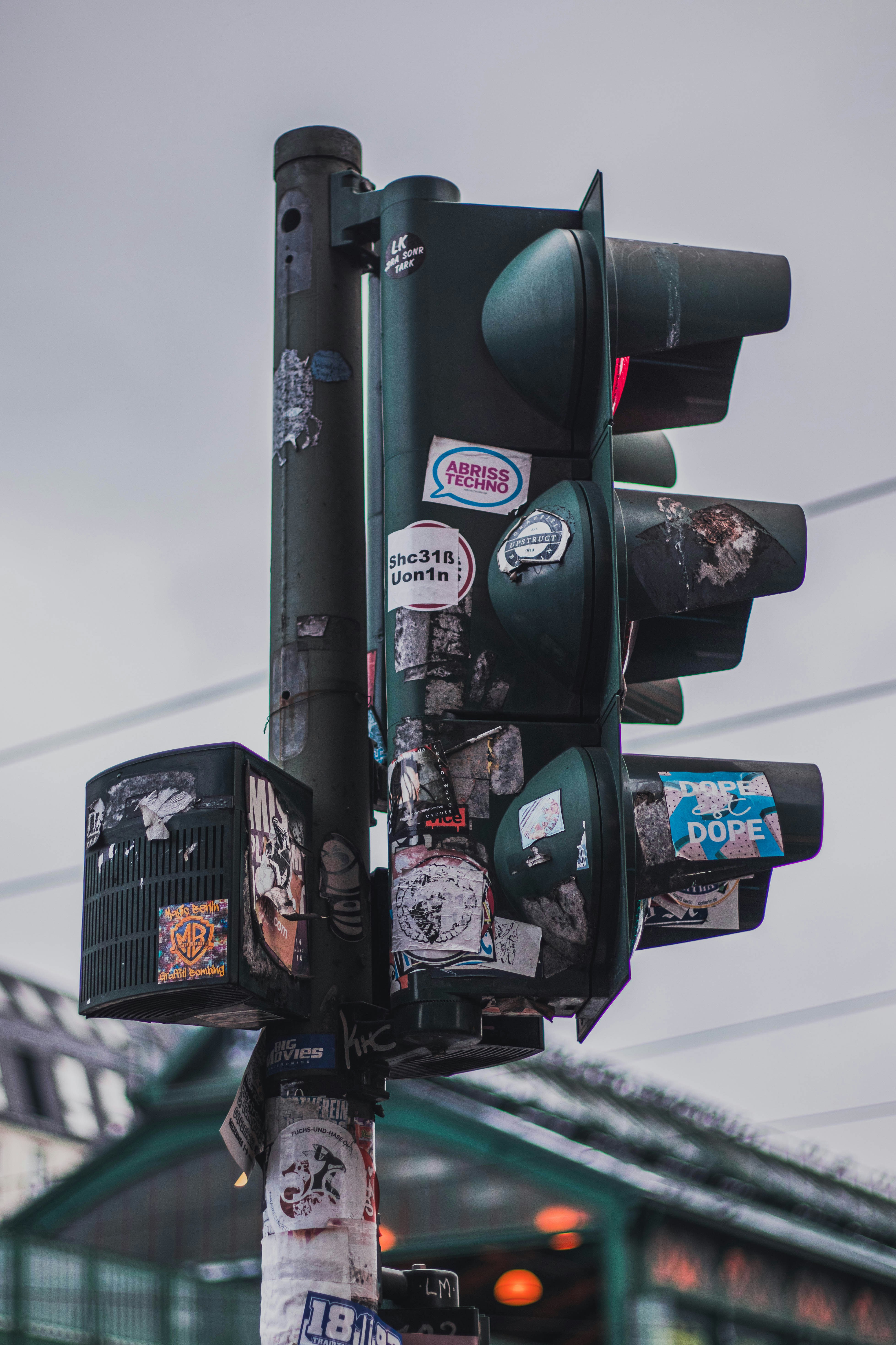 A traffic light with stickers all over it photo – Free Light Image on ...