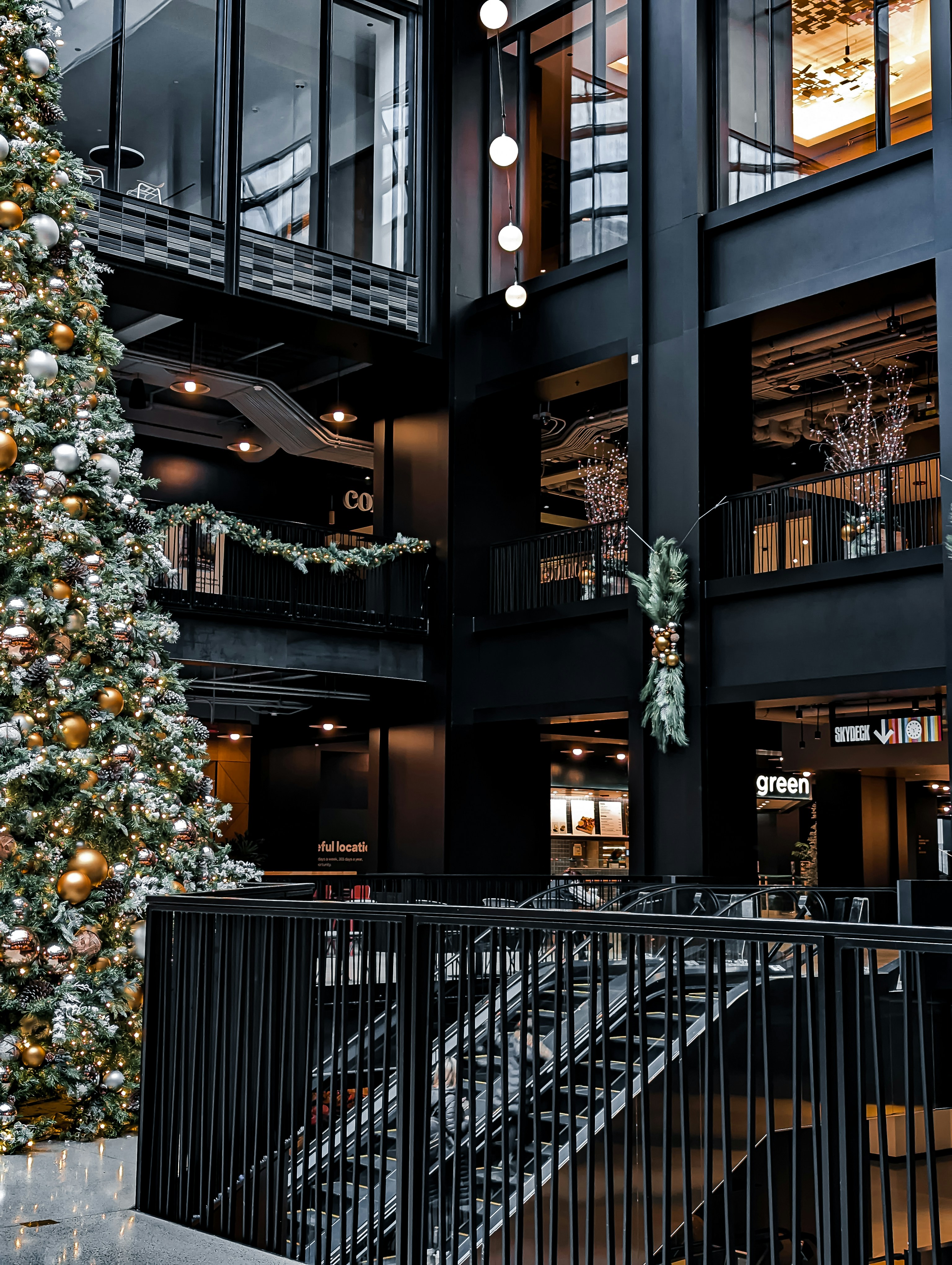 Christmas Tree in a Steel Atrium: Warm Glow Among Modern Balconies