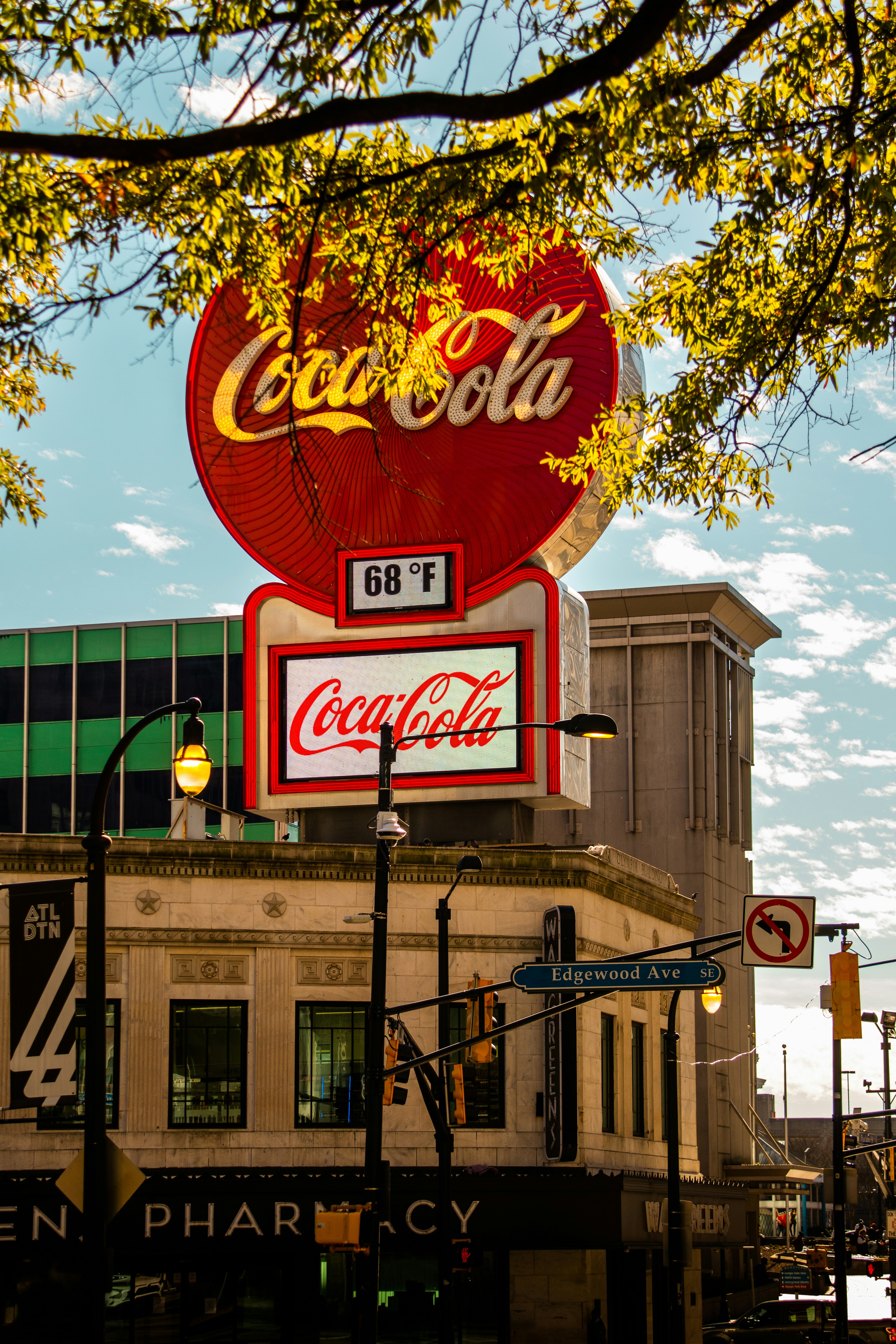 A large coca cola sign on top of a building photo – Free Ga Image on ...
