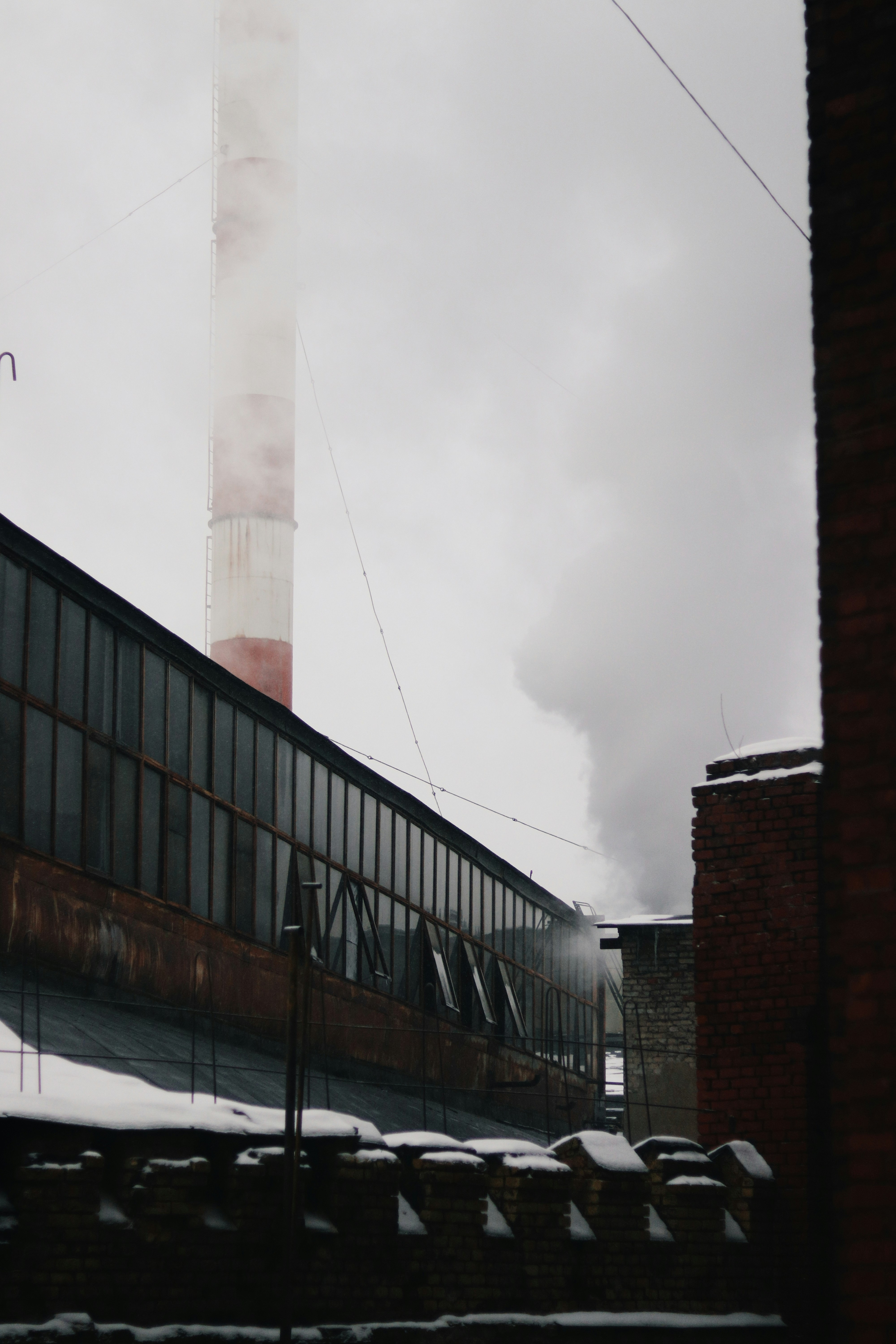 A factory building with smoke coming out of it photo – Free Smoke Image ...
