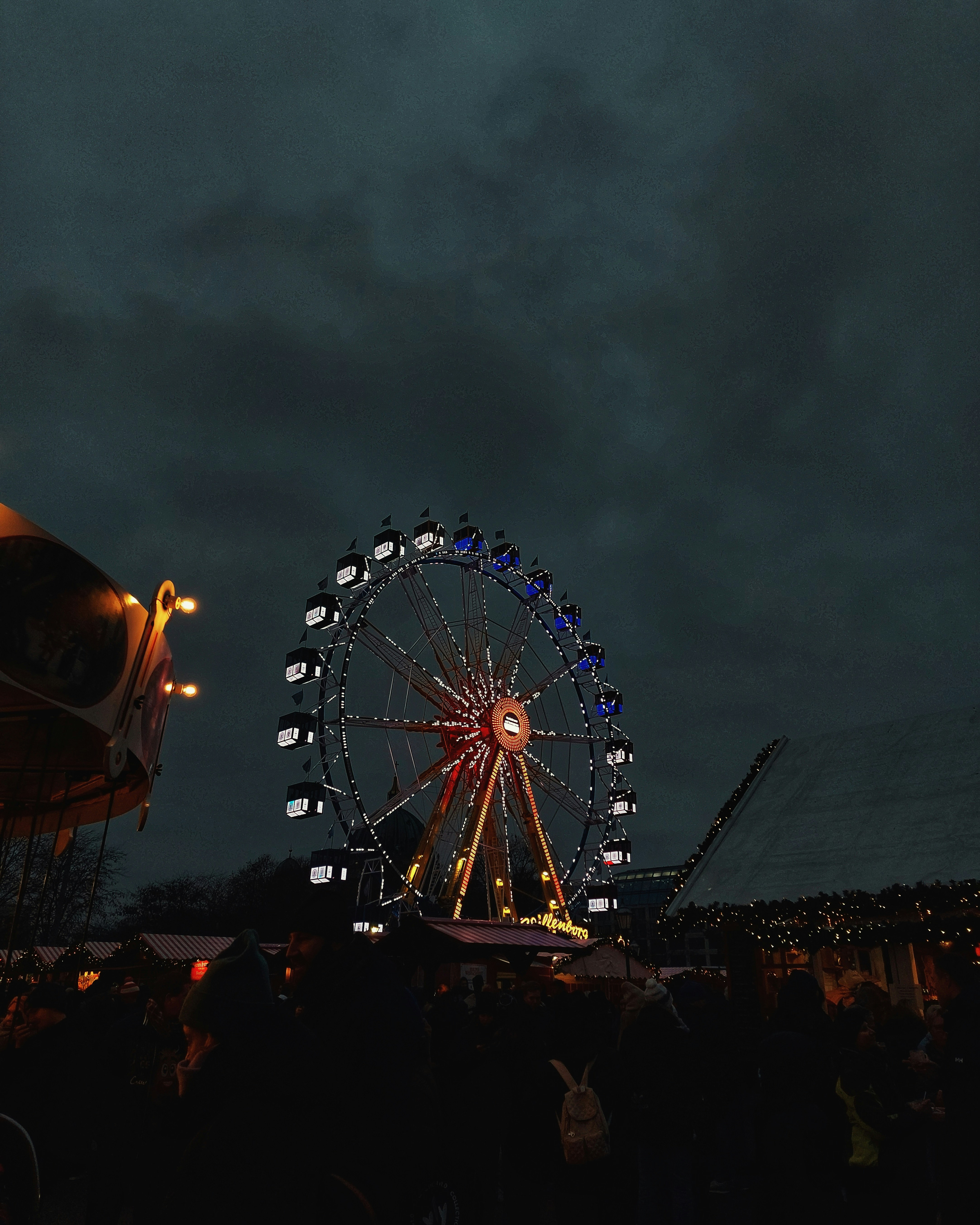 a ferris wheel is lit up at night