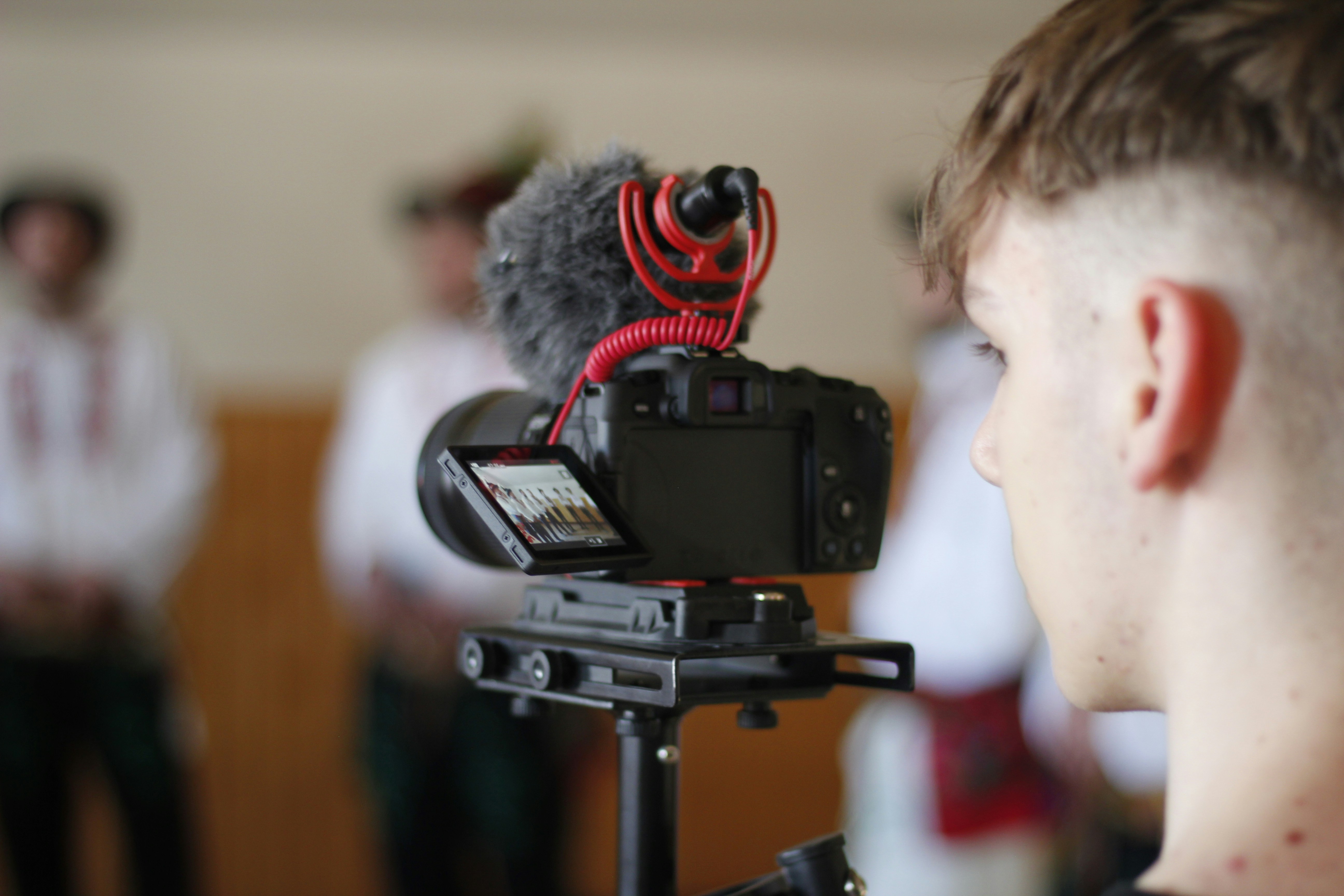 A man with a microphone on a tripod photo – Free Filmmaker Image on ...