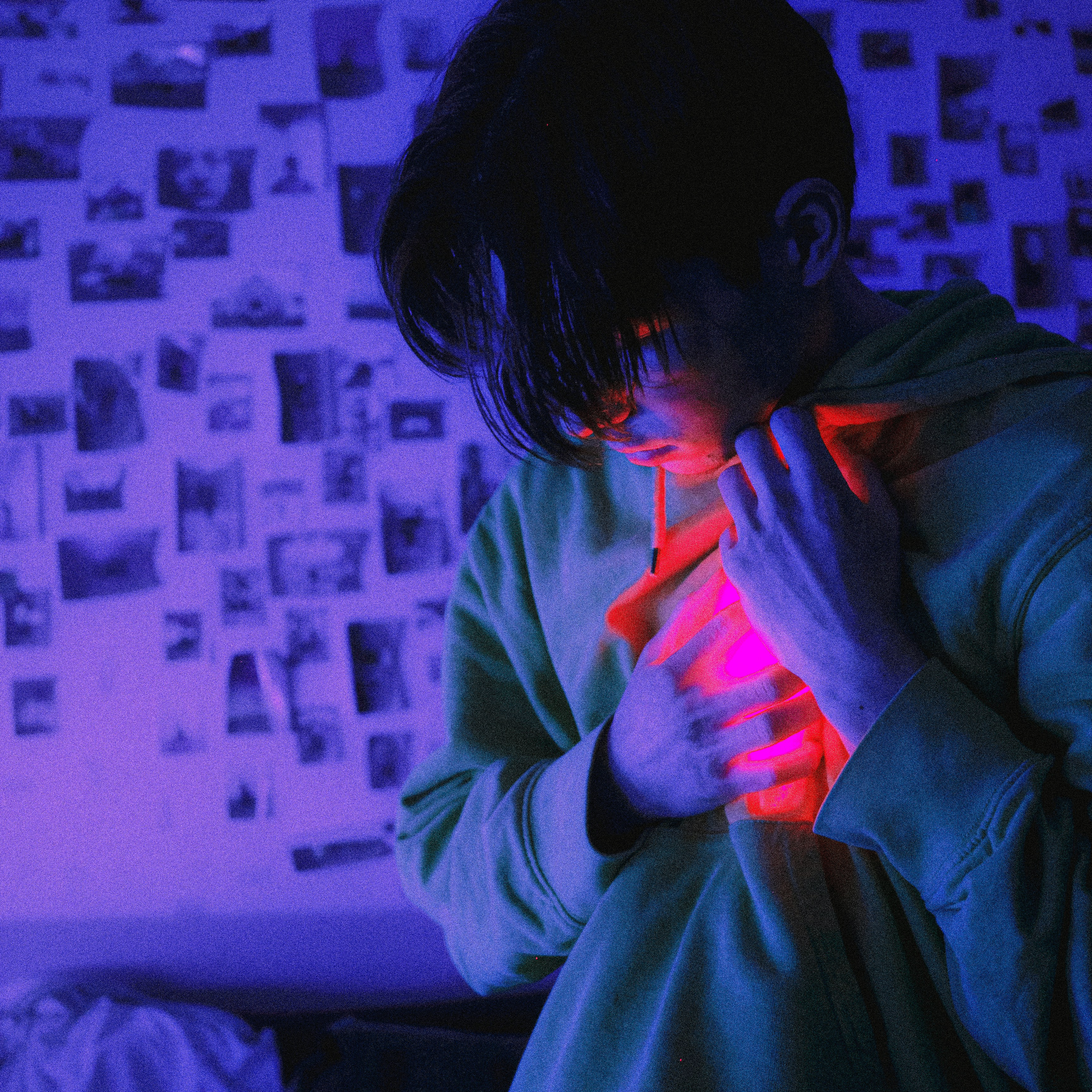a man standing in a room with his hands on his chest
