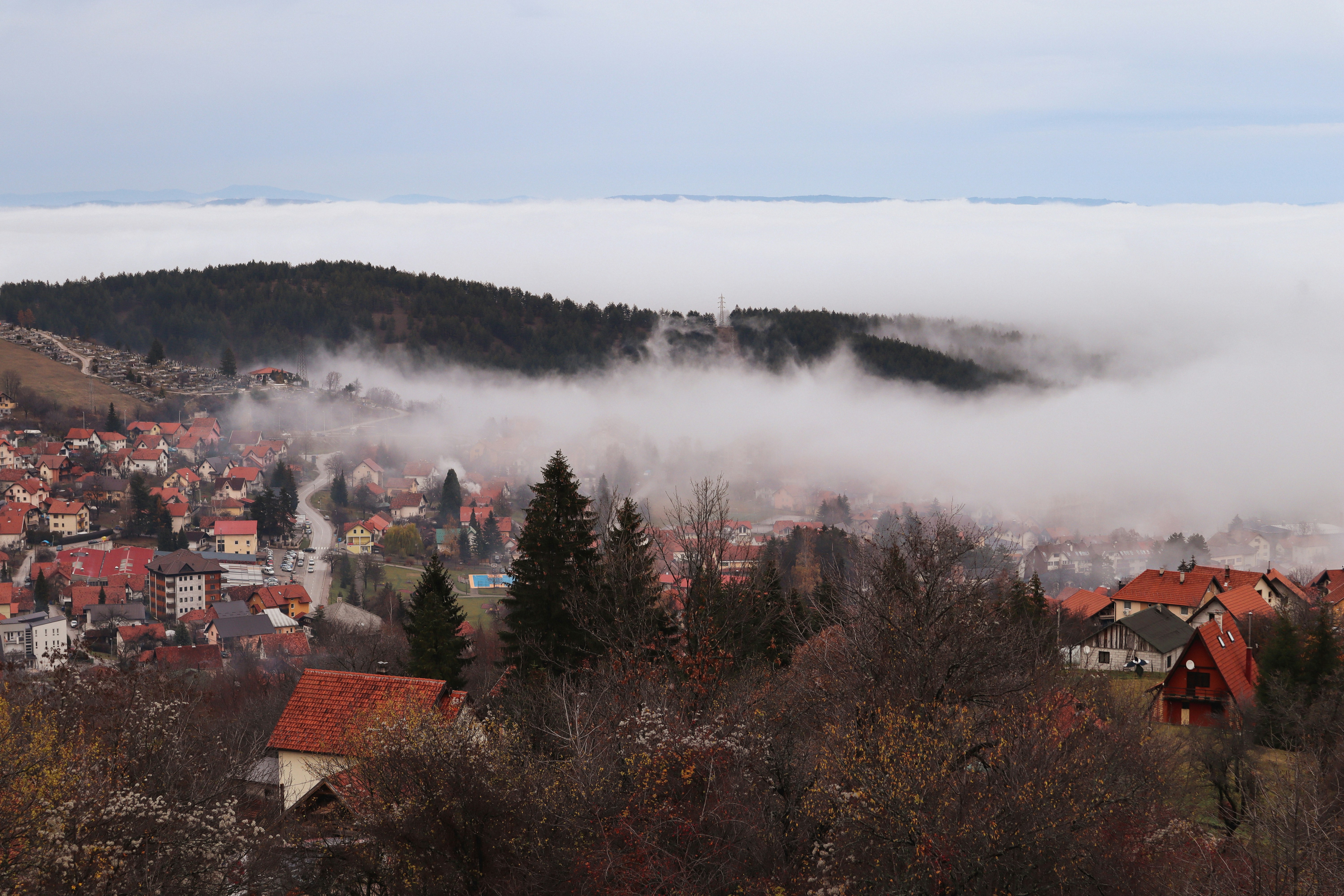 Mist-Laced Ridge: a hillside village waking beneath morning fog