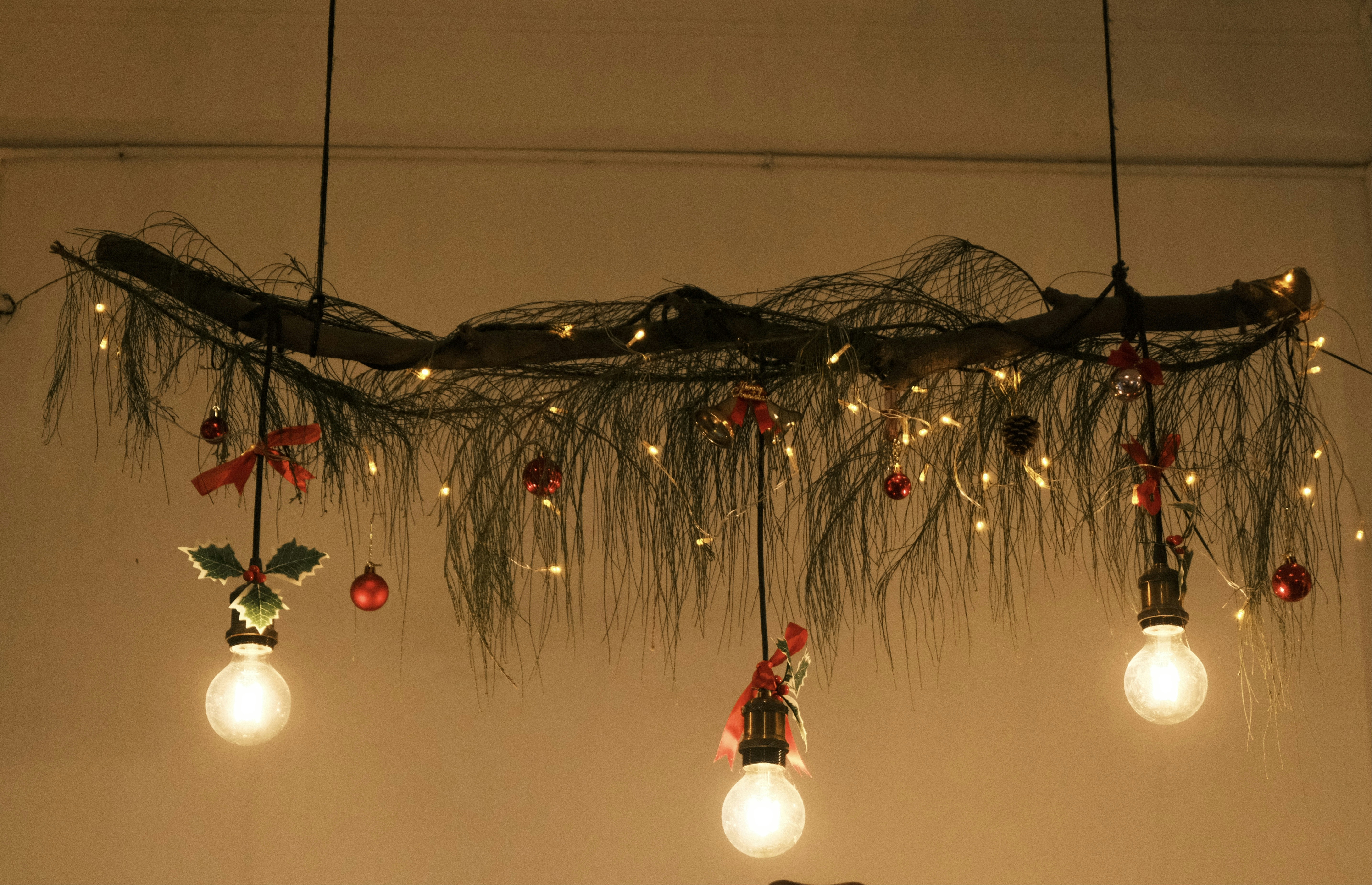 Hanging Holiday Glow: A Trio of Filament Lamps Casting Warm Orbs