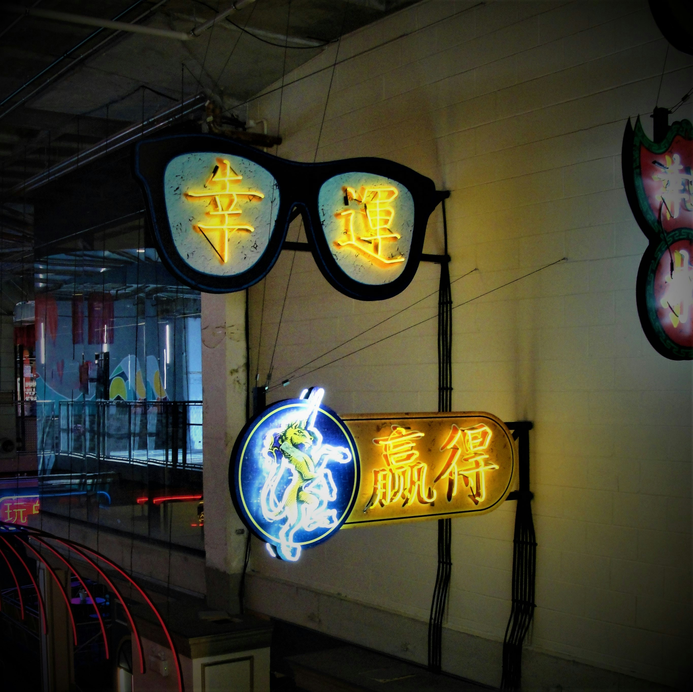 A couple of neon signs hanging from the side of a wall photo – Free ...