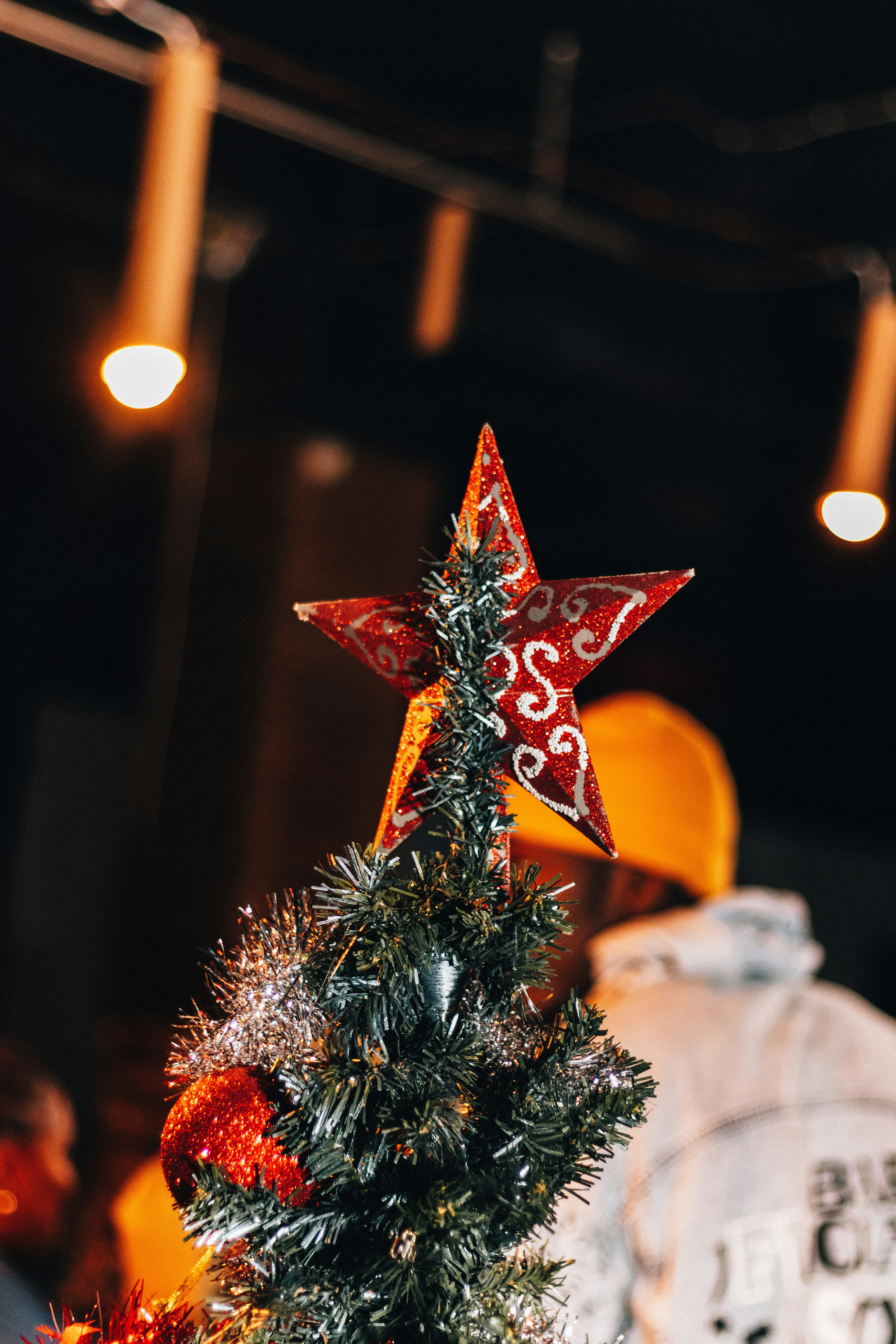 Star atop a cozy Christmas tree in a warmly lit scene