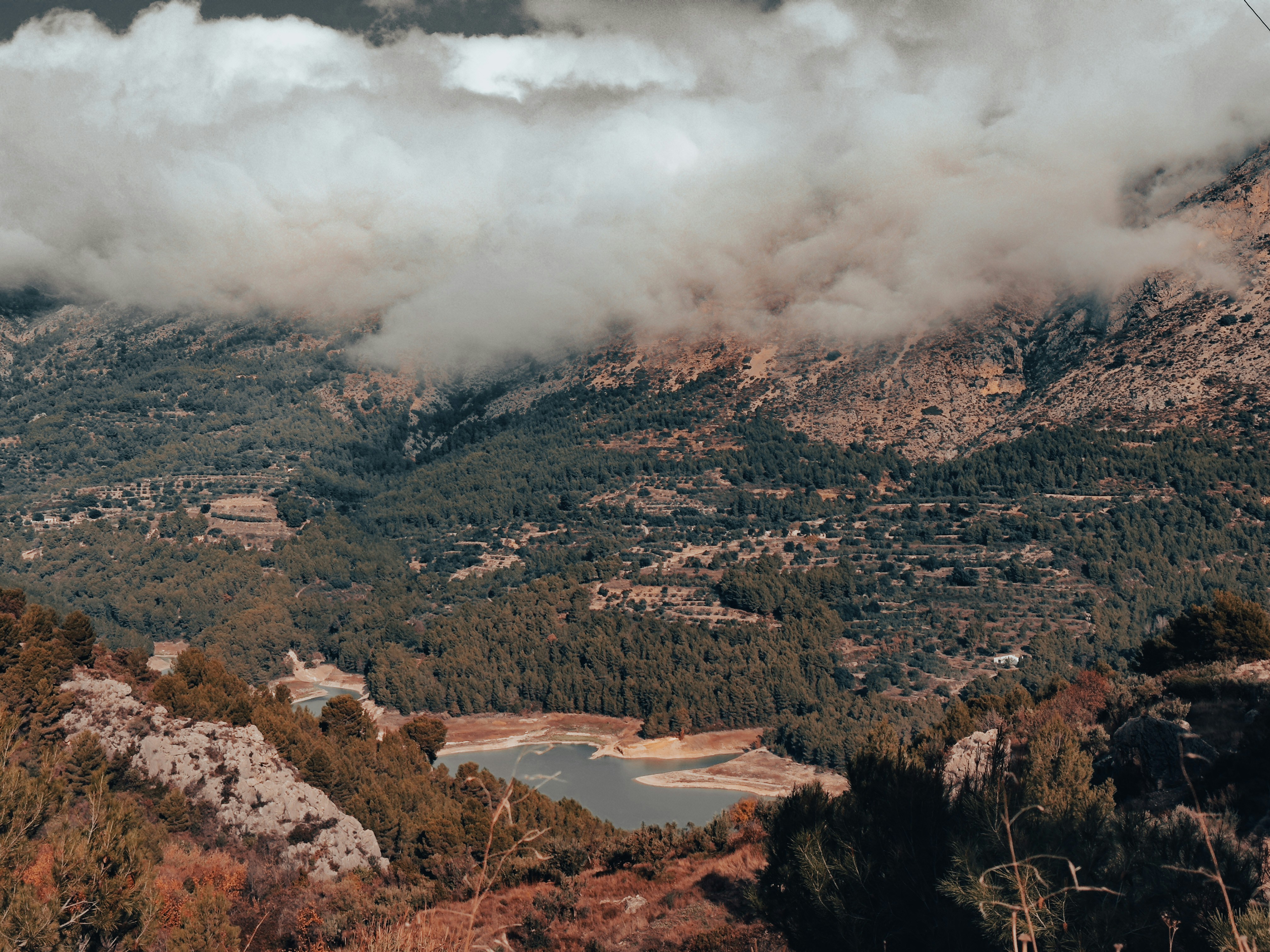 Cloud-Crowned Ridge Over a Turquoise Mountain Lake