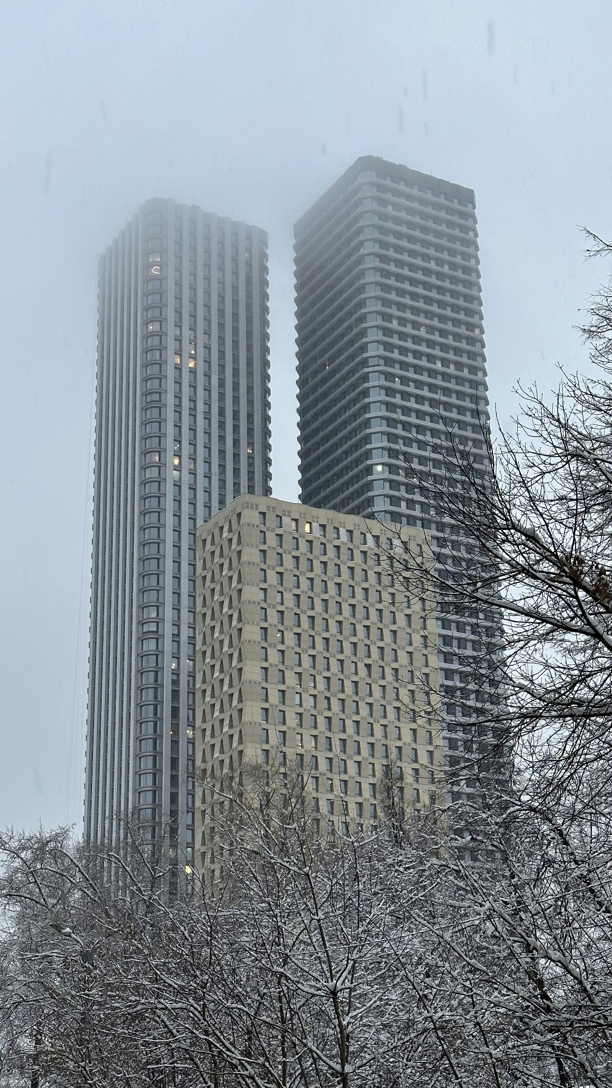 a couple of tall buildings sitting next to each other