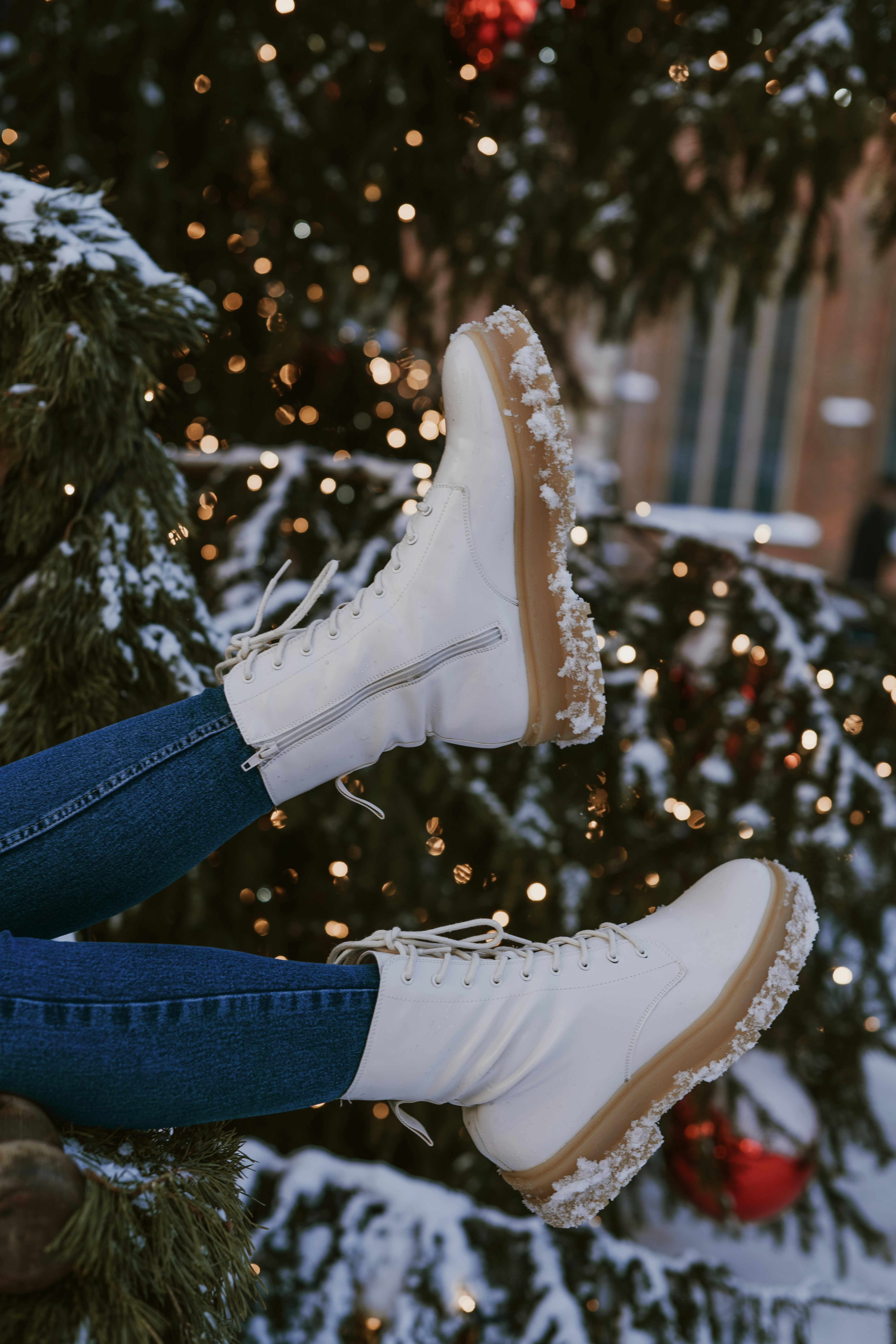 A pair of white boots hanging from a christmas tree photo – Free Shoe ...