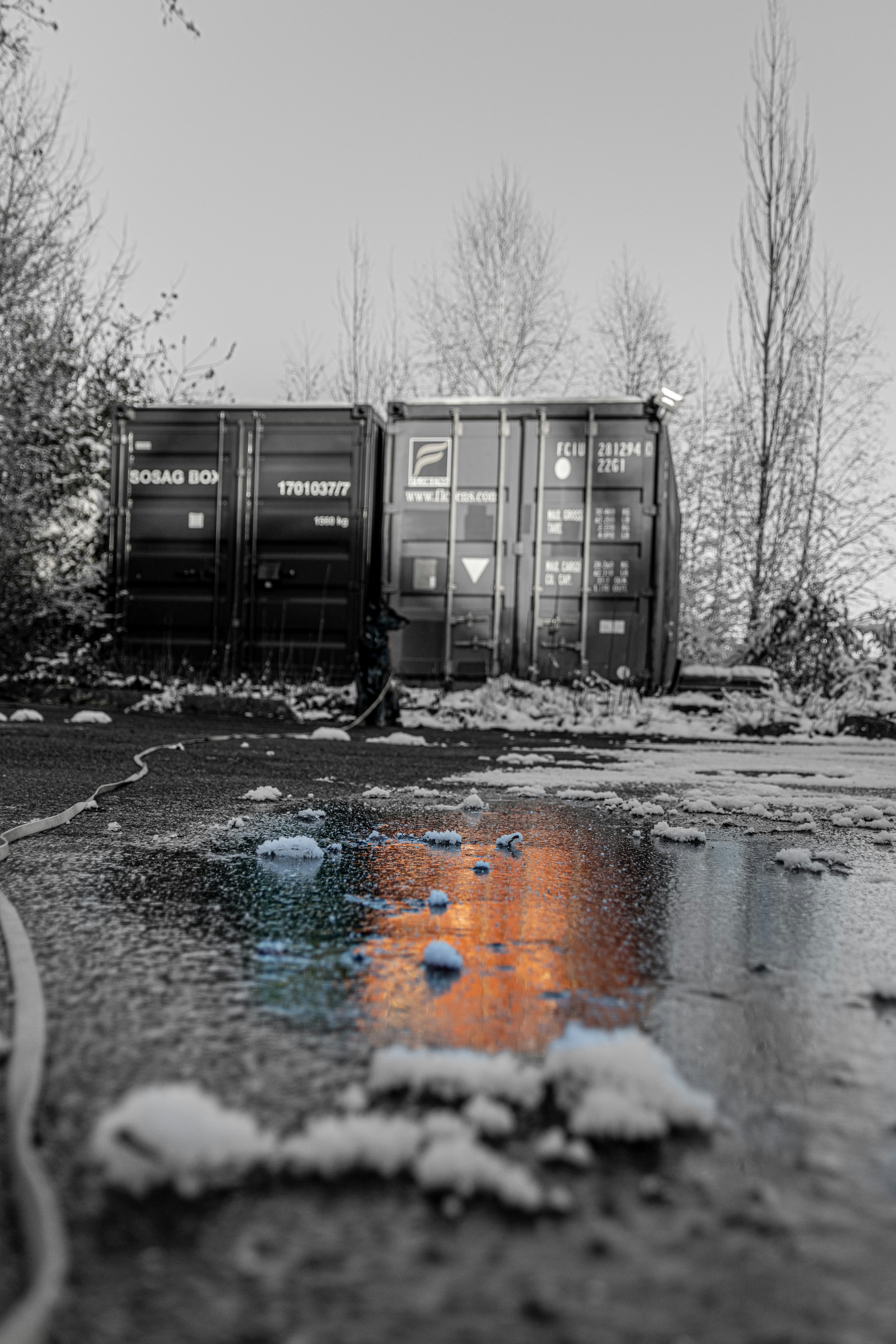 a black and white photo of a puddle of water