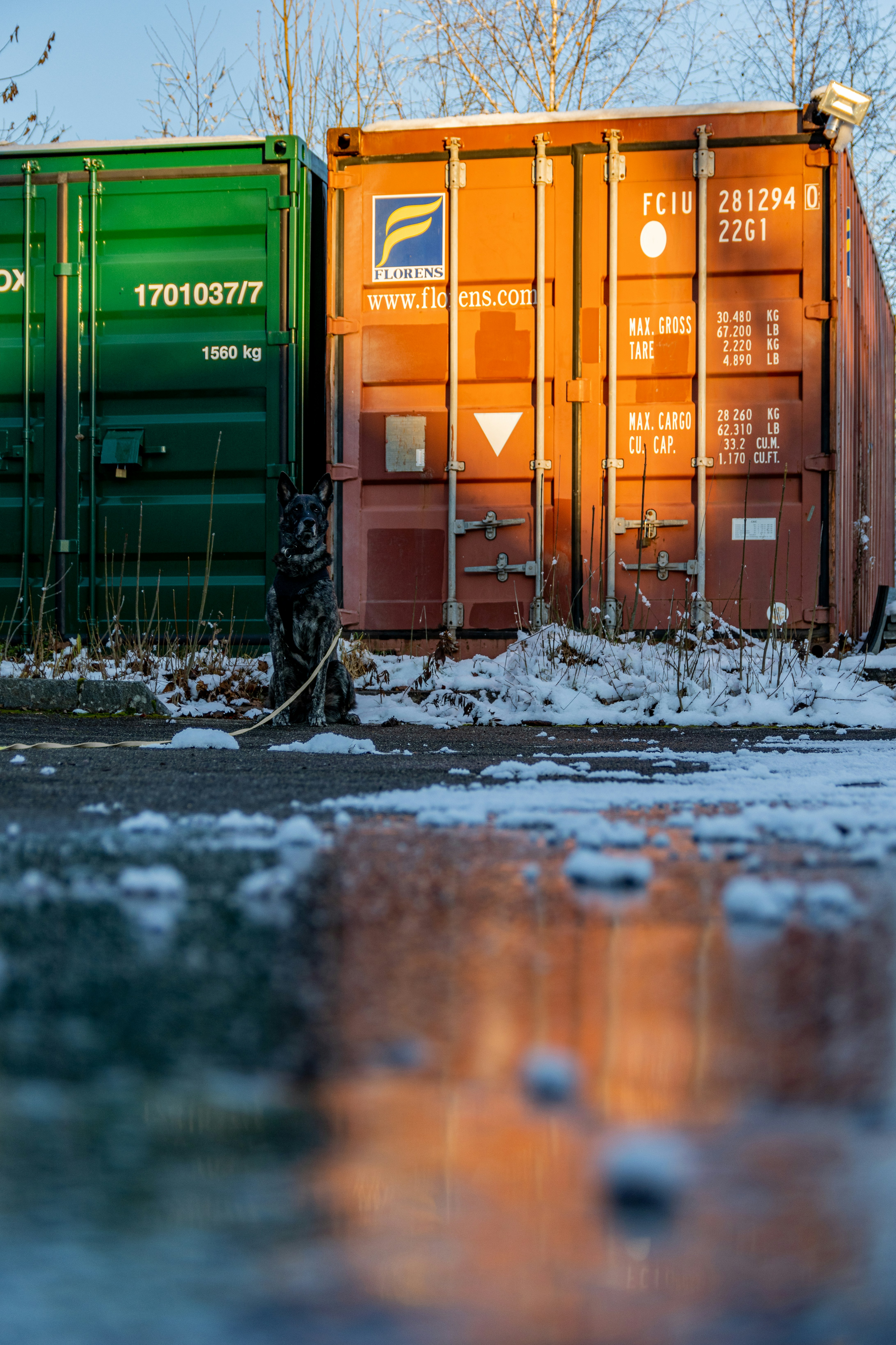 A couple of green and orange containers sitting next to each other ...
