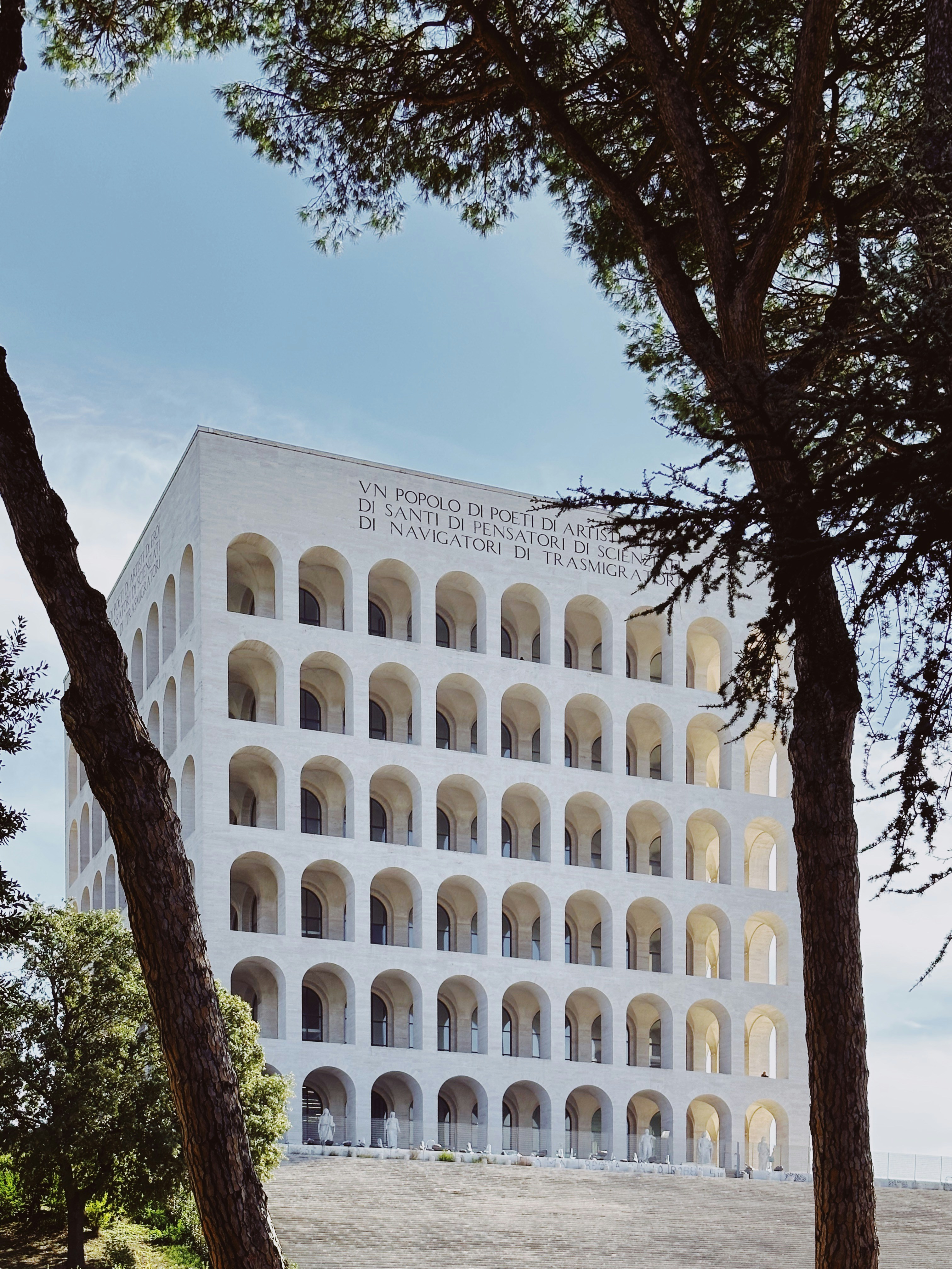 A large white building surrounded by trees on a sunny day photo – Free ...