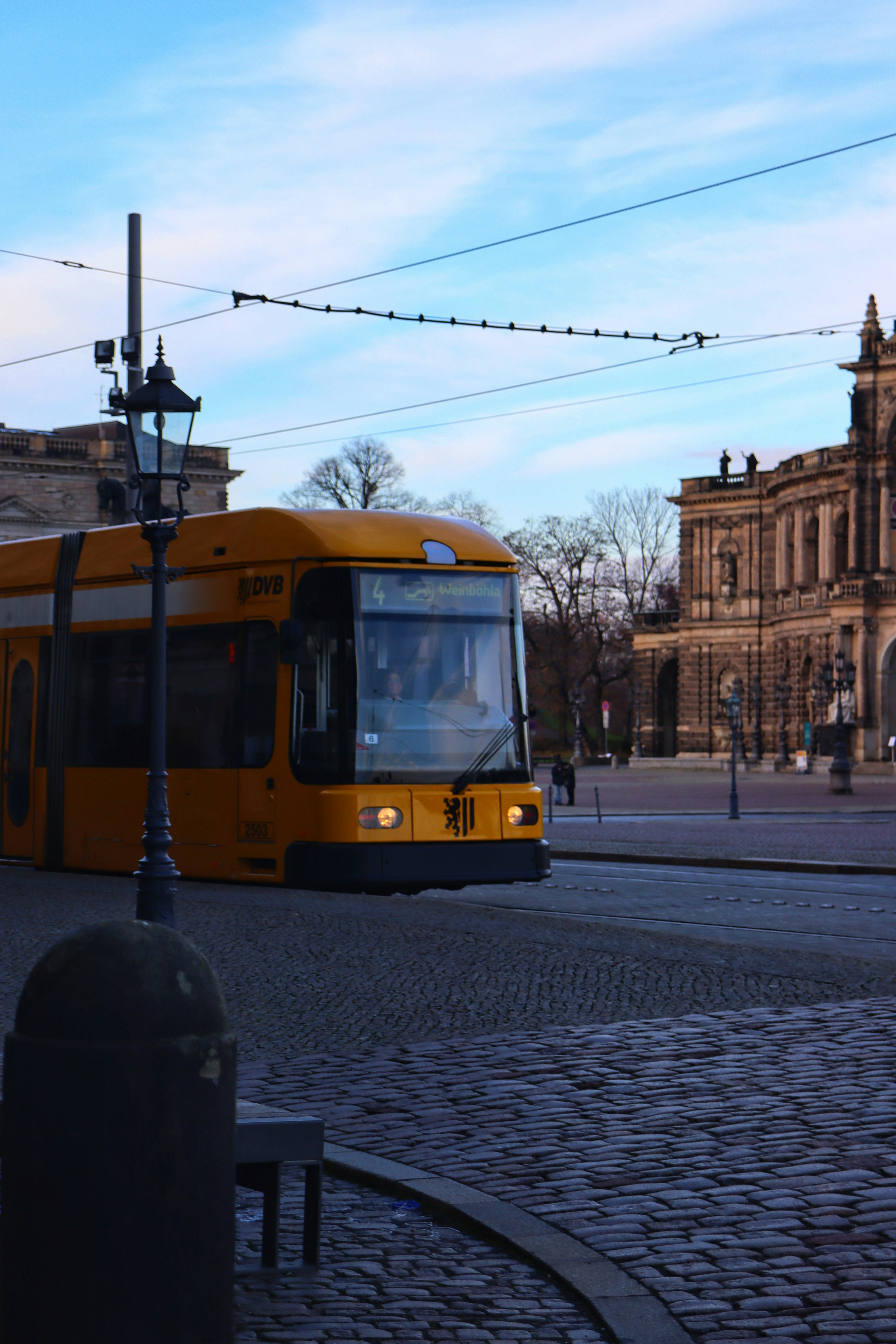 Un bus jaune descendant une rue à côté d’un grand immeuble photo ...