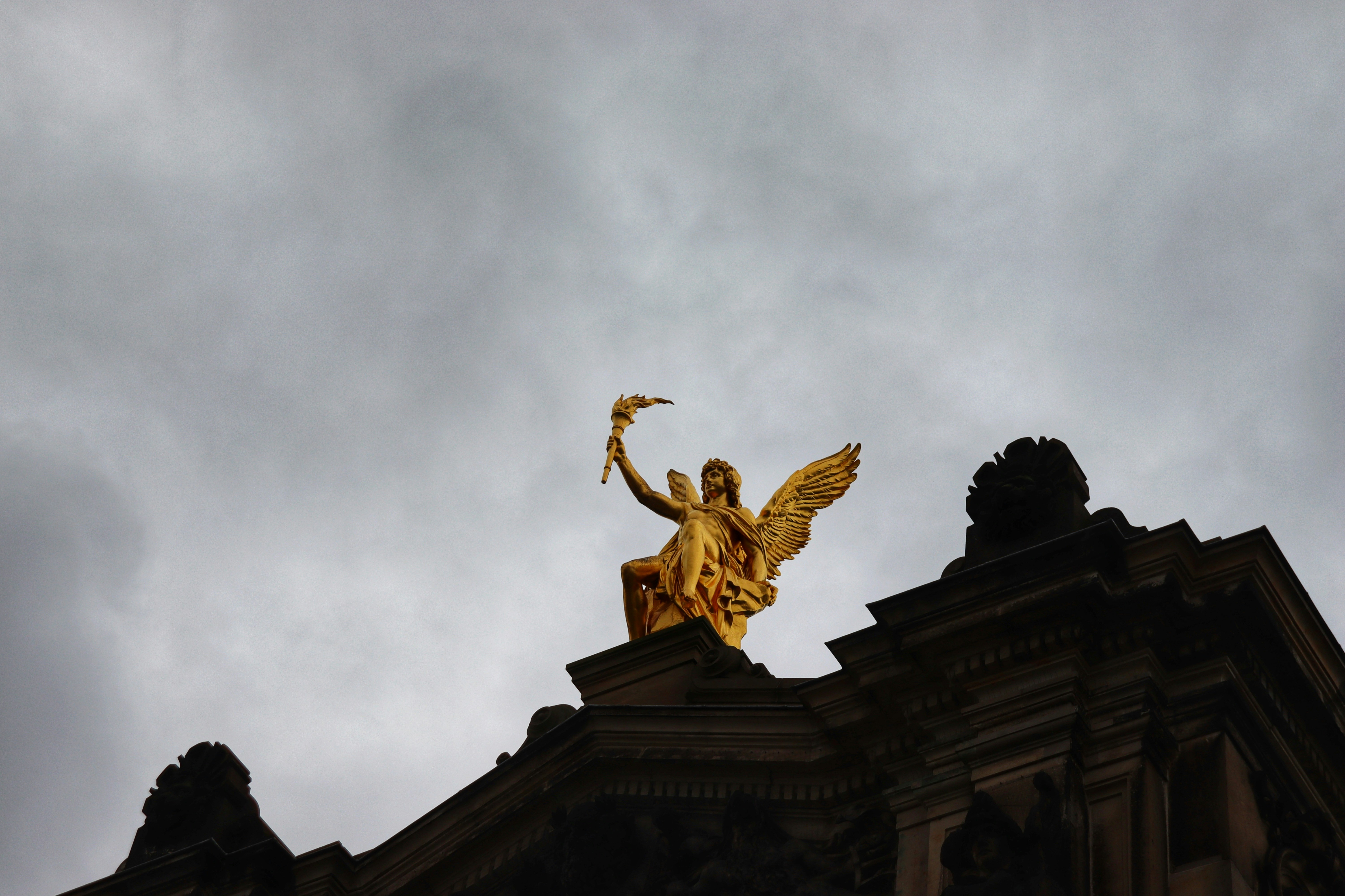 A statue of an angel on top of a building photo – Free Building Image ...