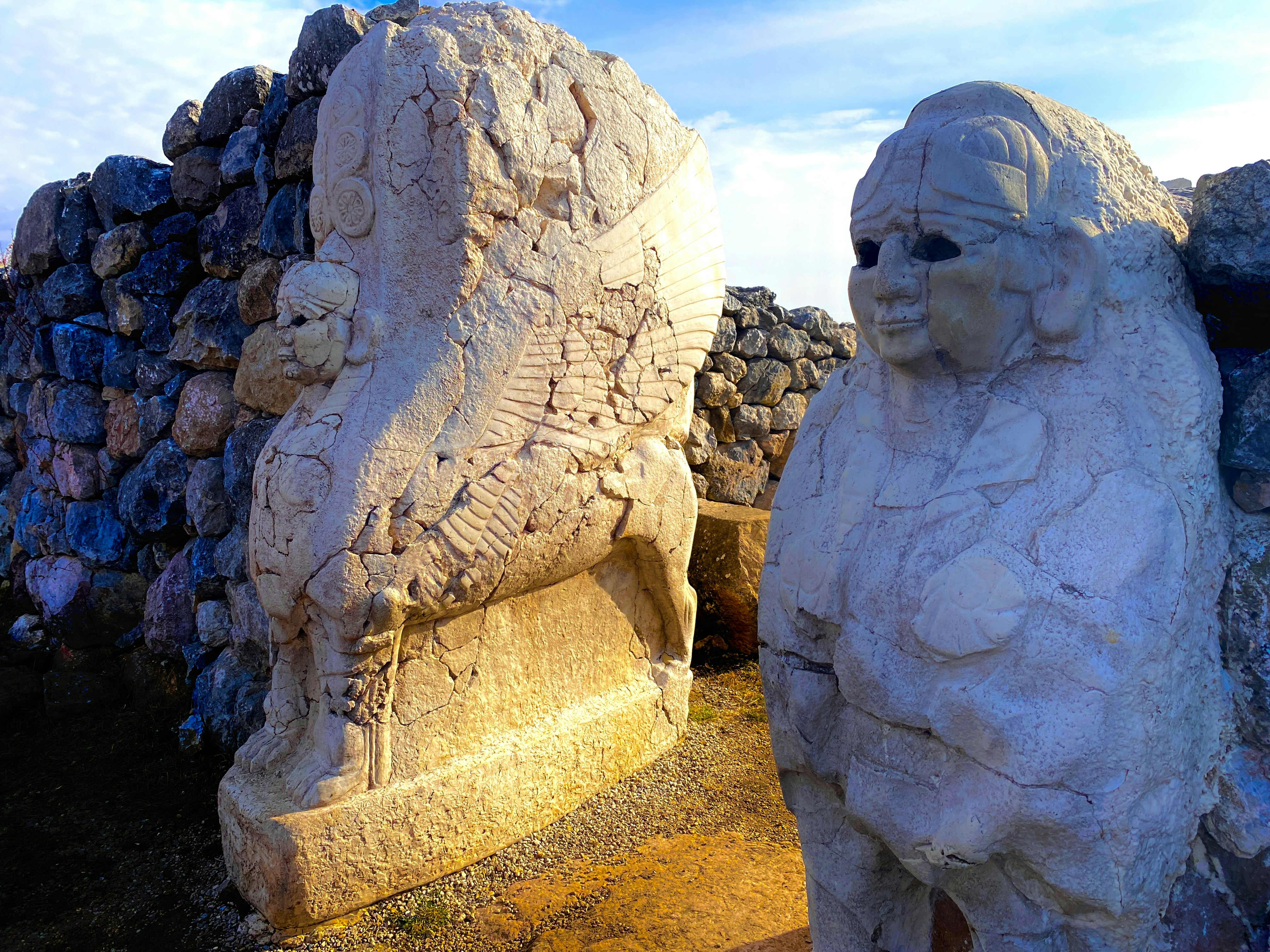 Winged Guardians Along a Sunlit Stone Wall