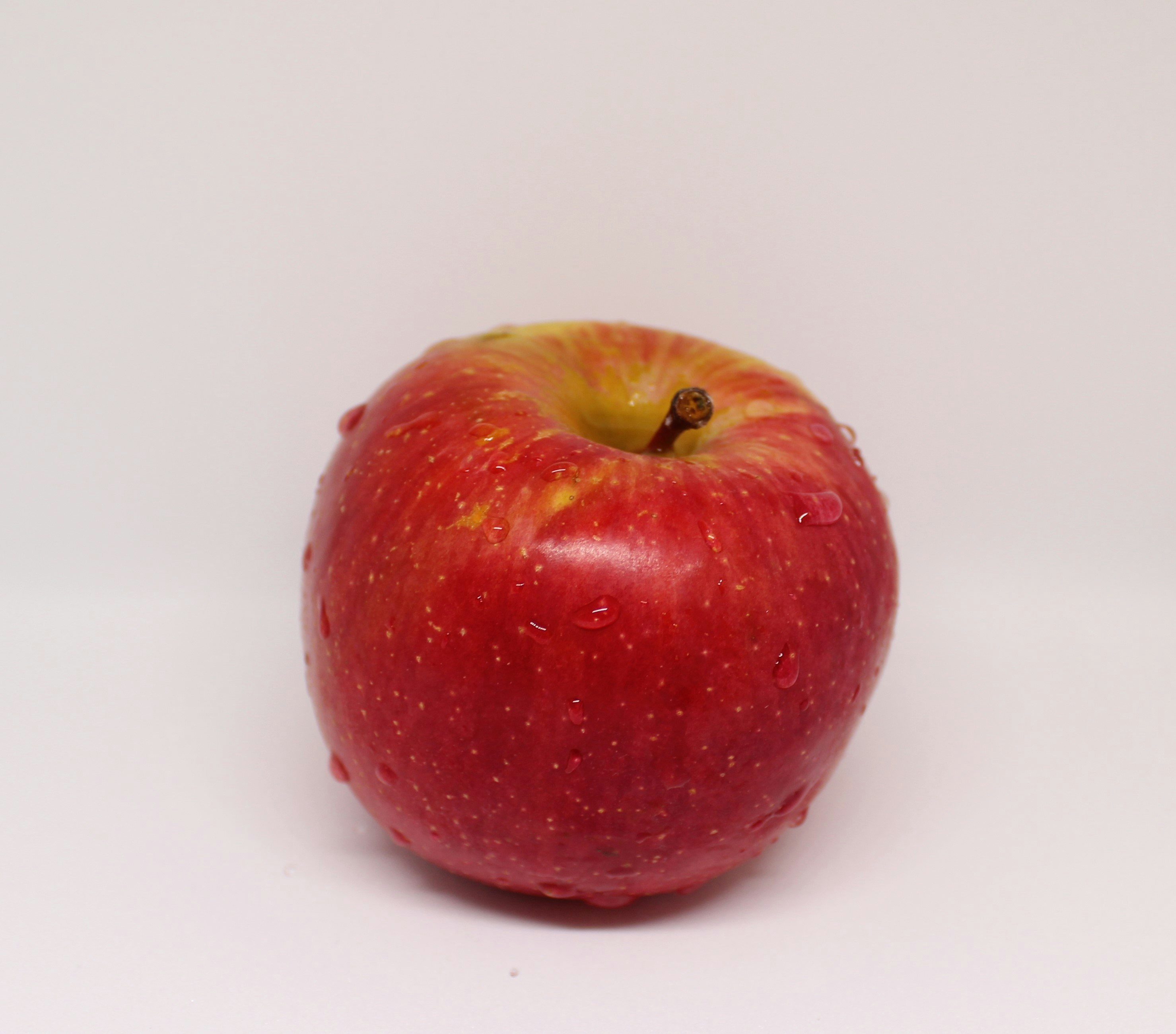 (An apple a day keeps the doctor away) | a red apple sitting on top of a white table
