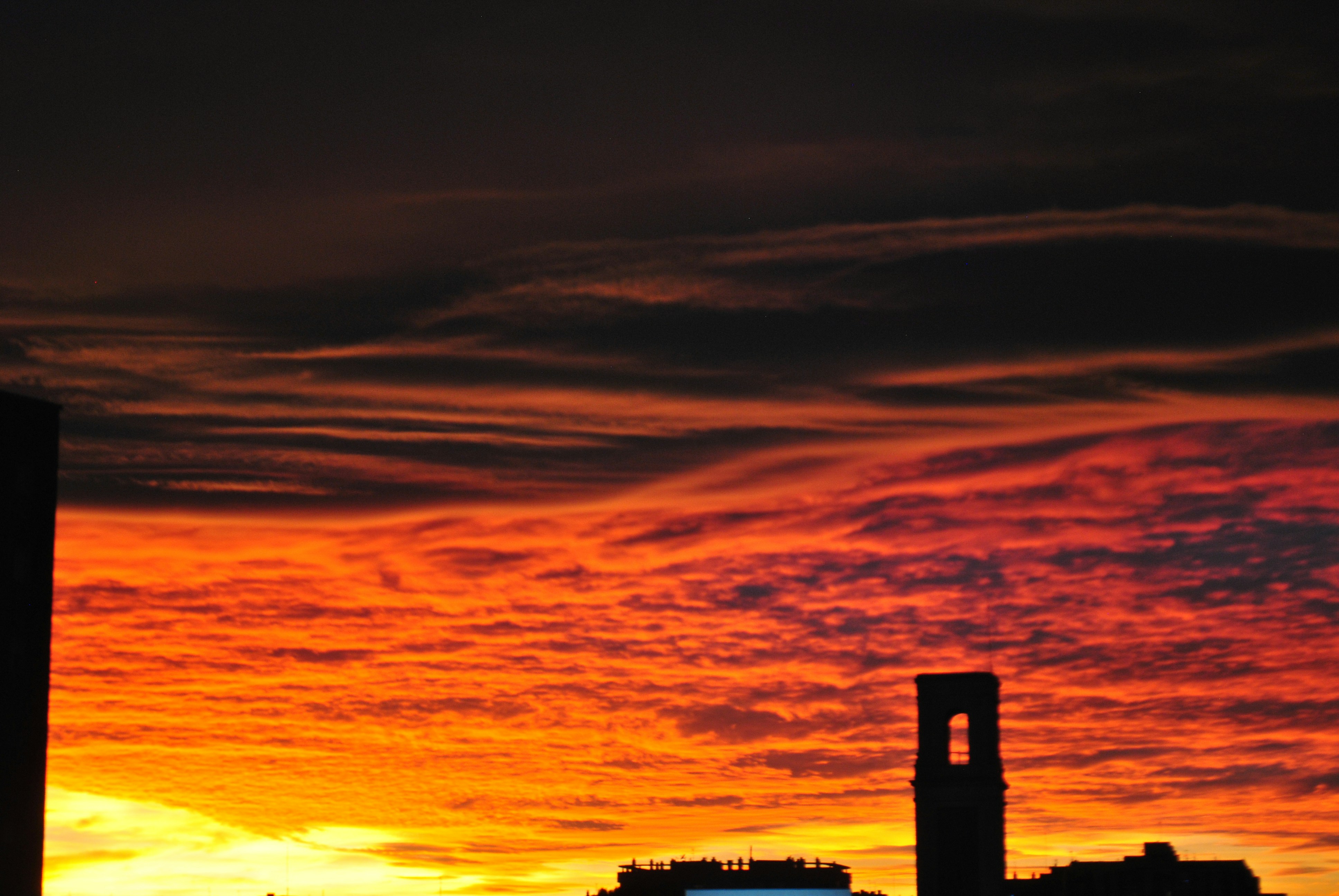 Molten Horizon Over a City Silhouette: Tower Against a Fiery Sky