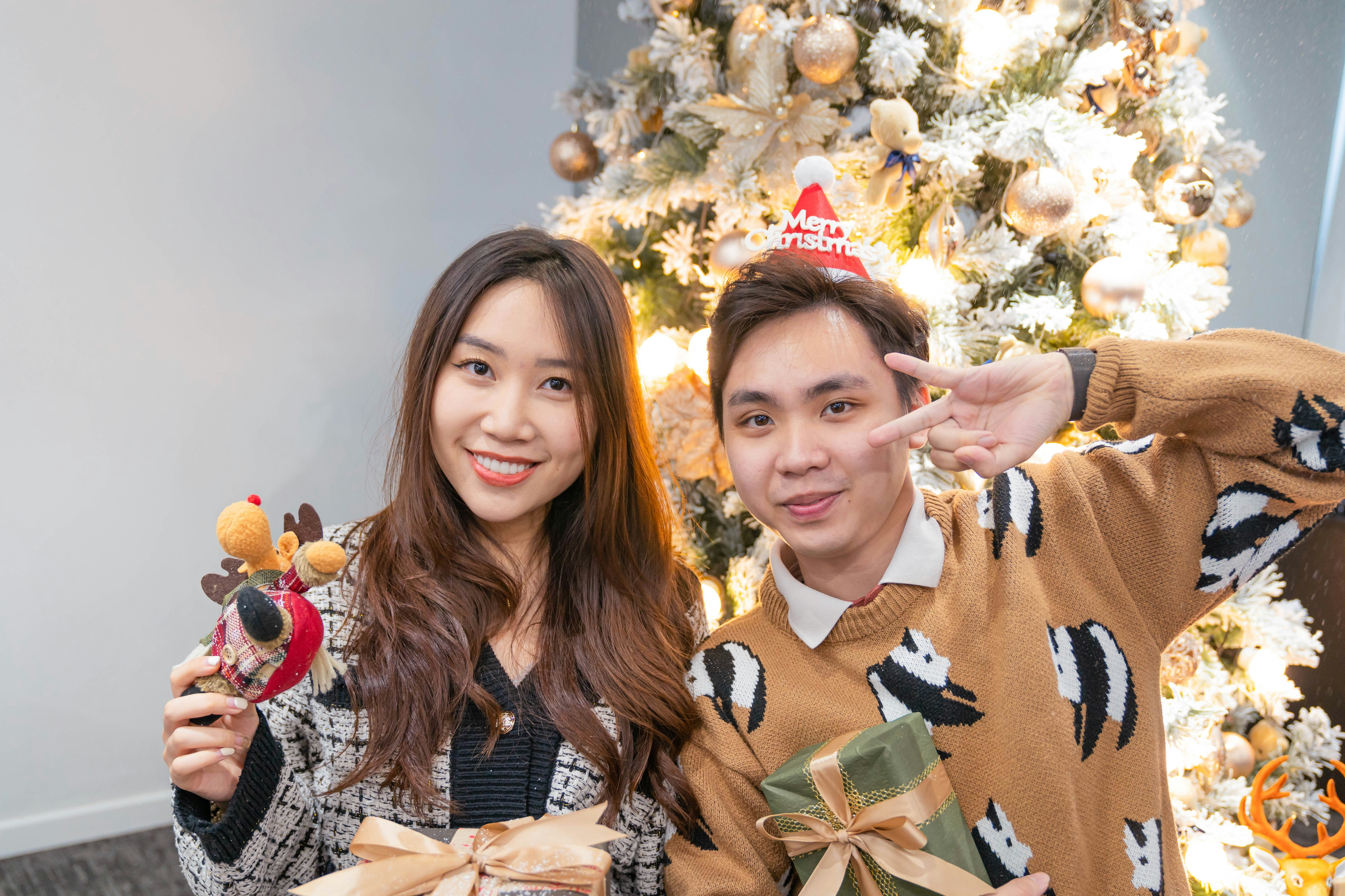 Festive duo under glowing tree: a candid holiday moment