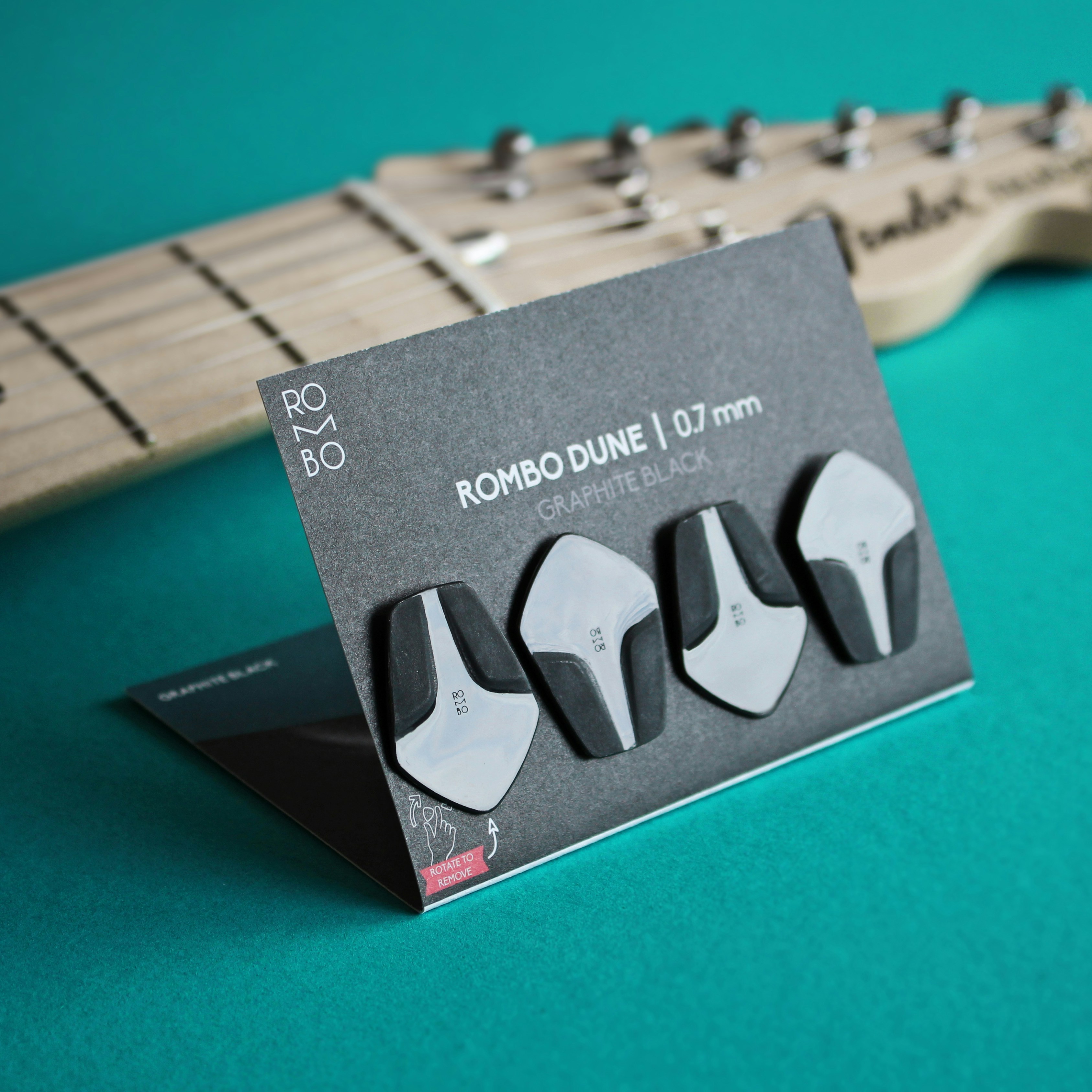 A close up of a guitar picker near a guitar photo – Free Guitar Image ...