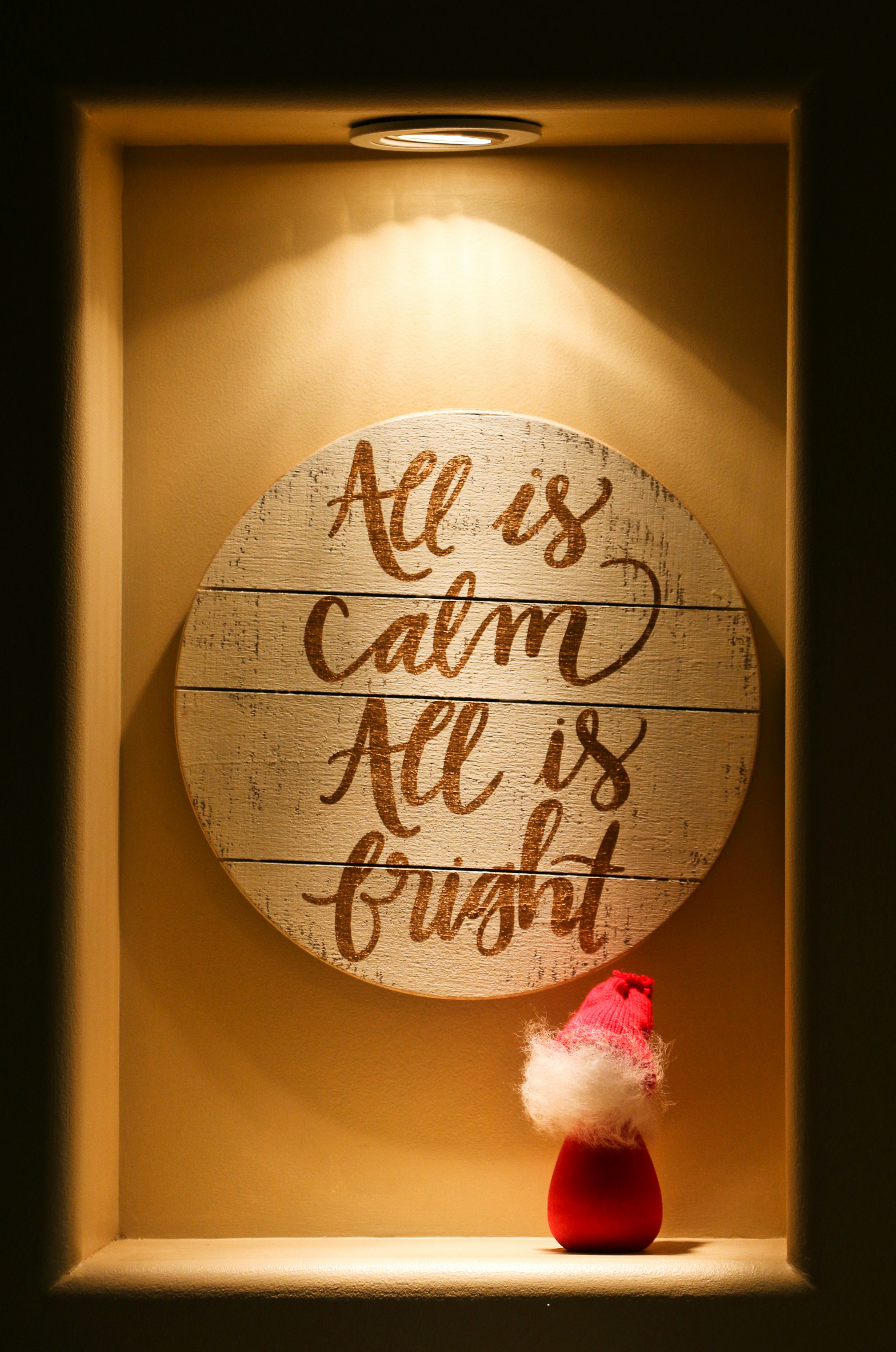 Haloed Rustic Round Sign: All Is Calm, All Is Bright in a Quiet Nook