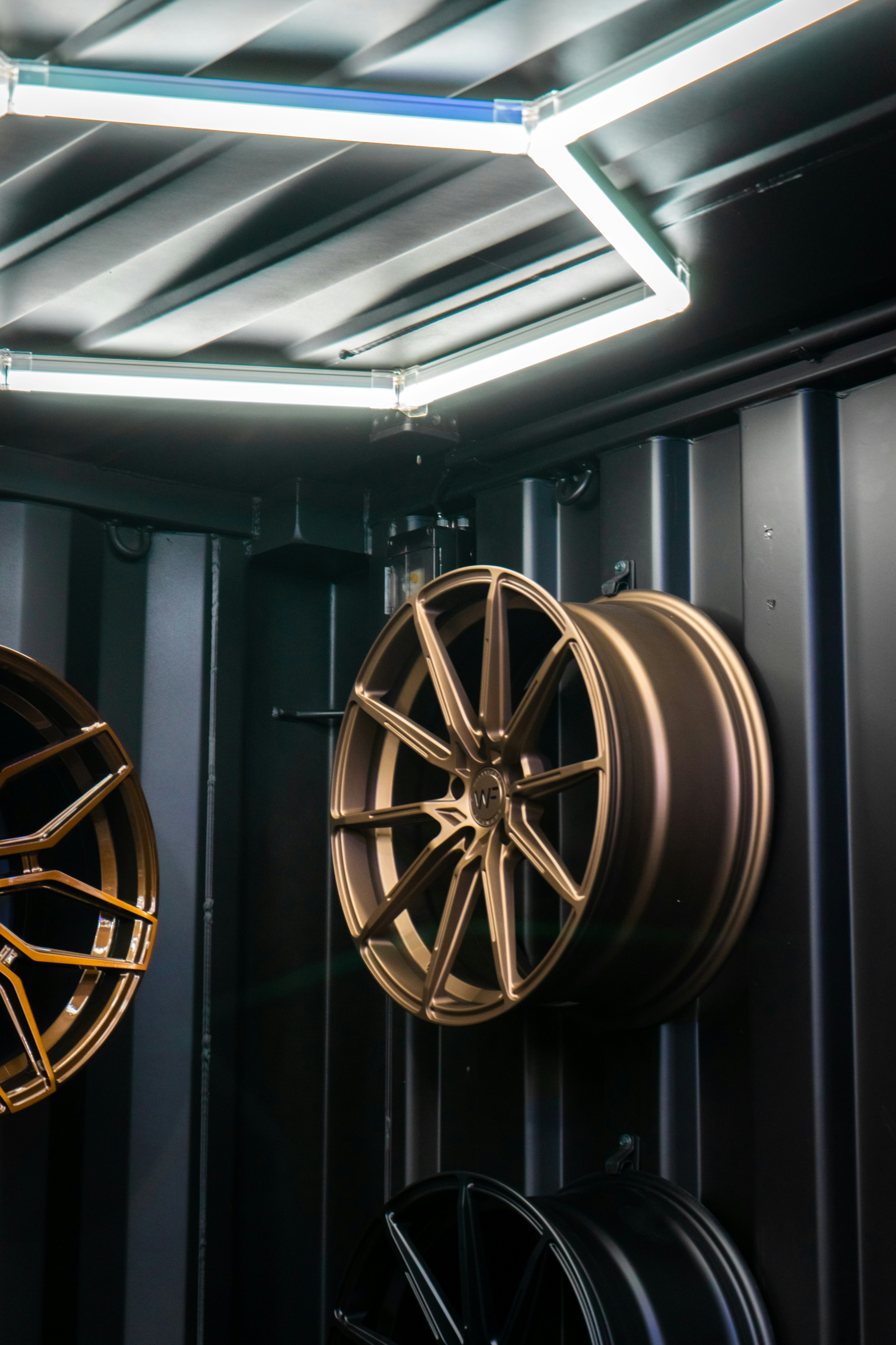 Bronze Rim in a Neon-Lit Wall Display
