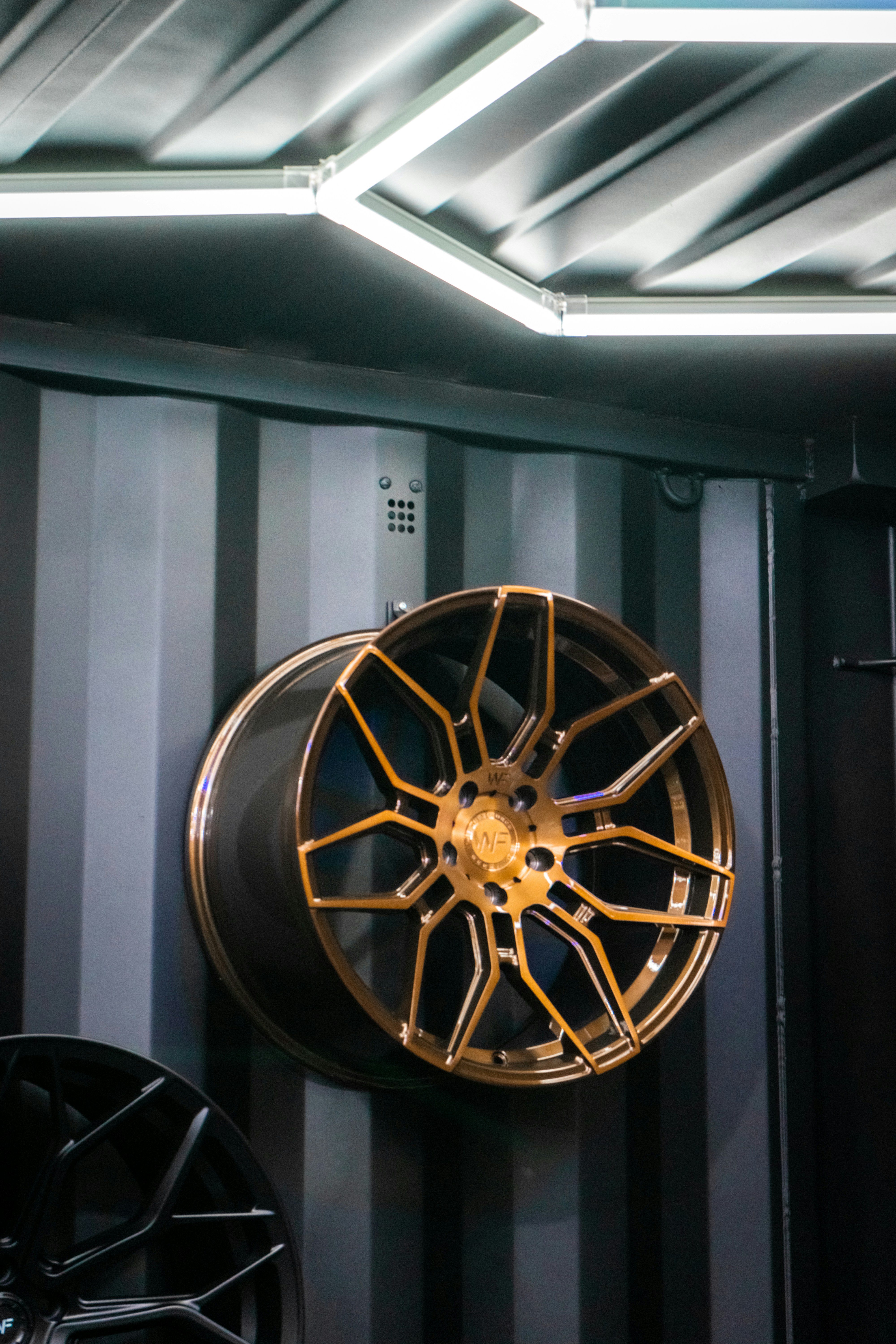 Sleek bronze wheel glow in a modern showroom