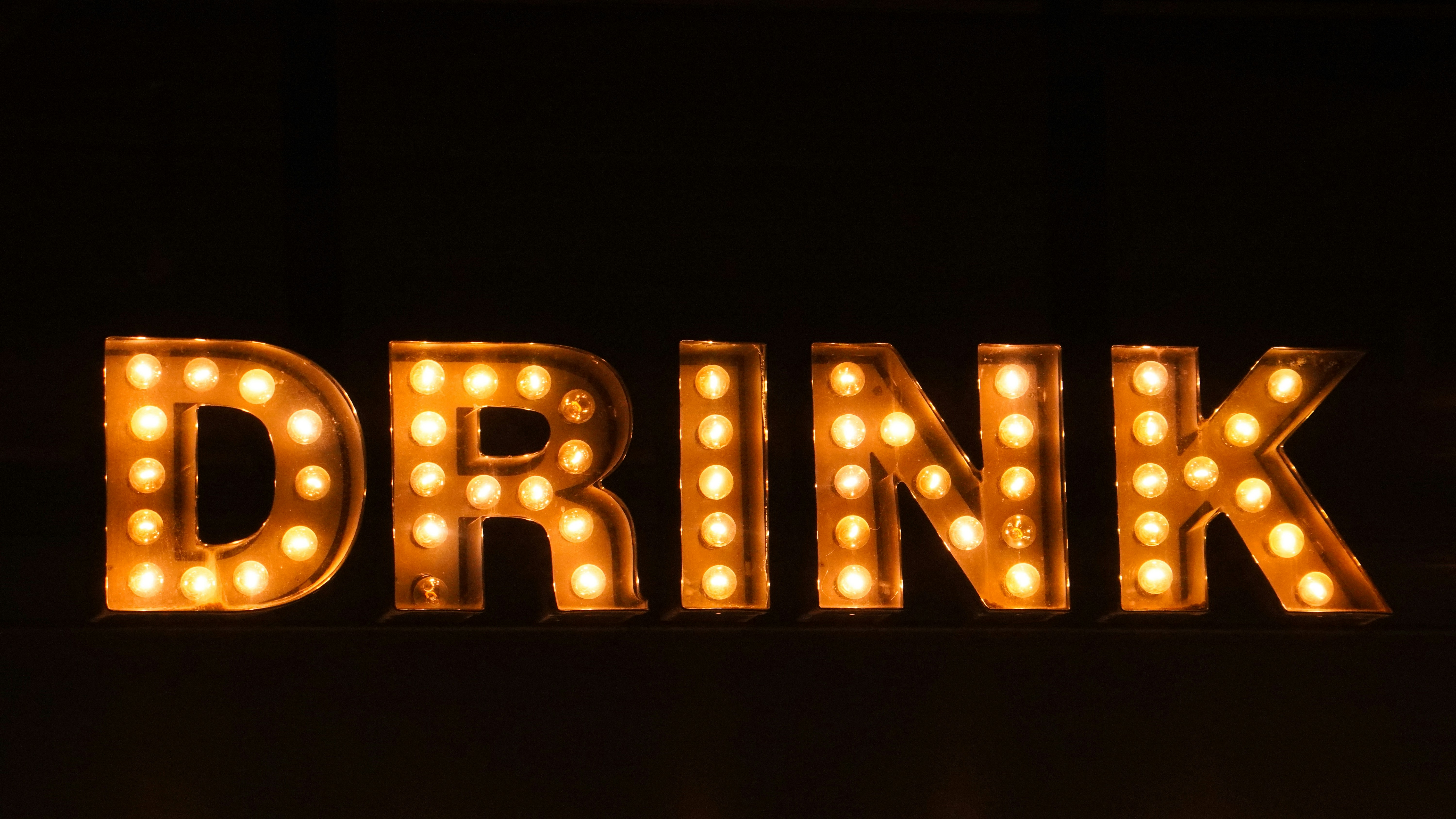 Marquee DRINK: Vintage Bulb Letters Casting a Warm Night Glow