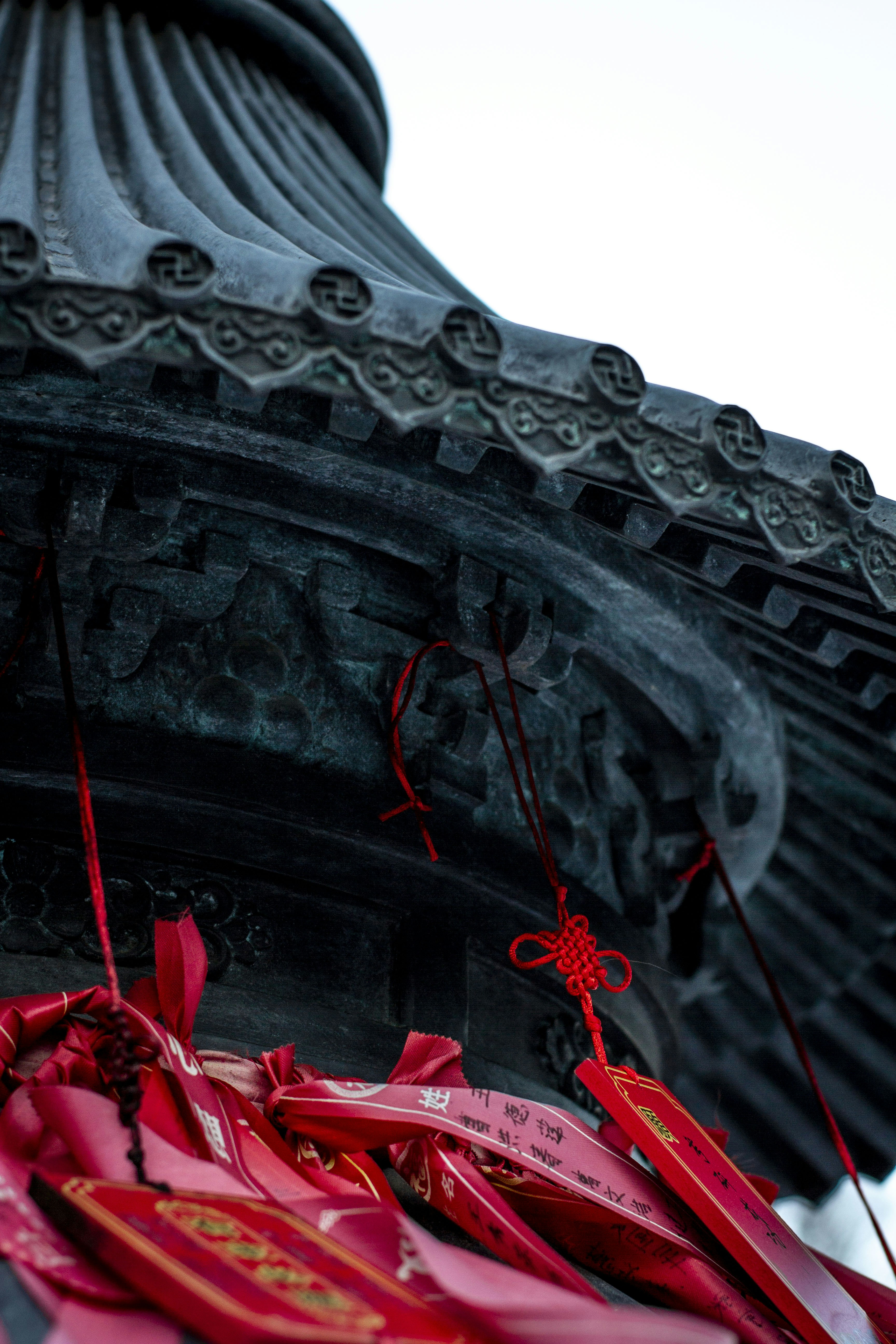 A close up of a large metal object with red ribbons photo – Free ...