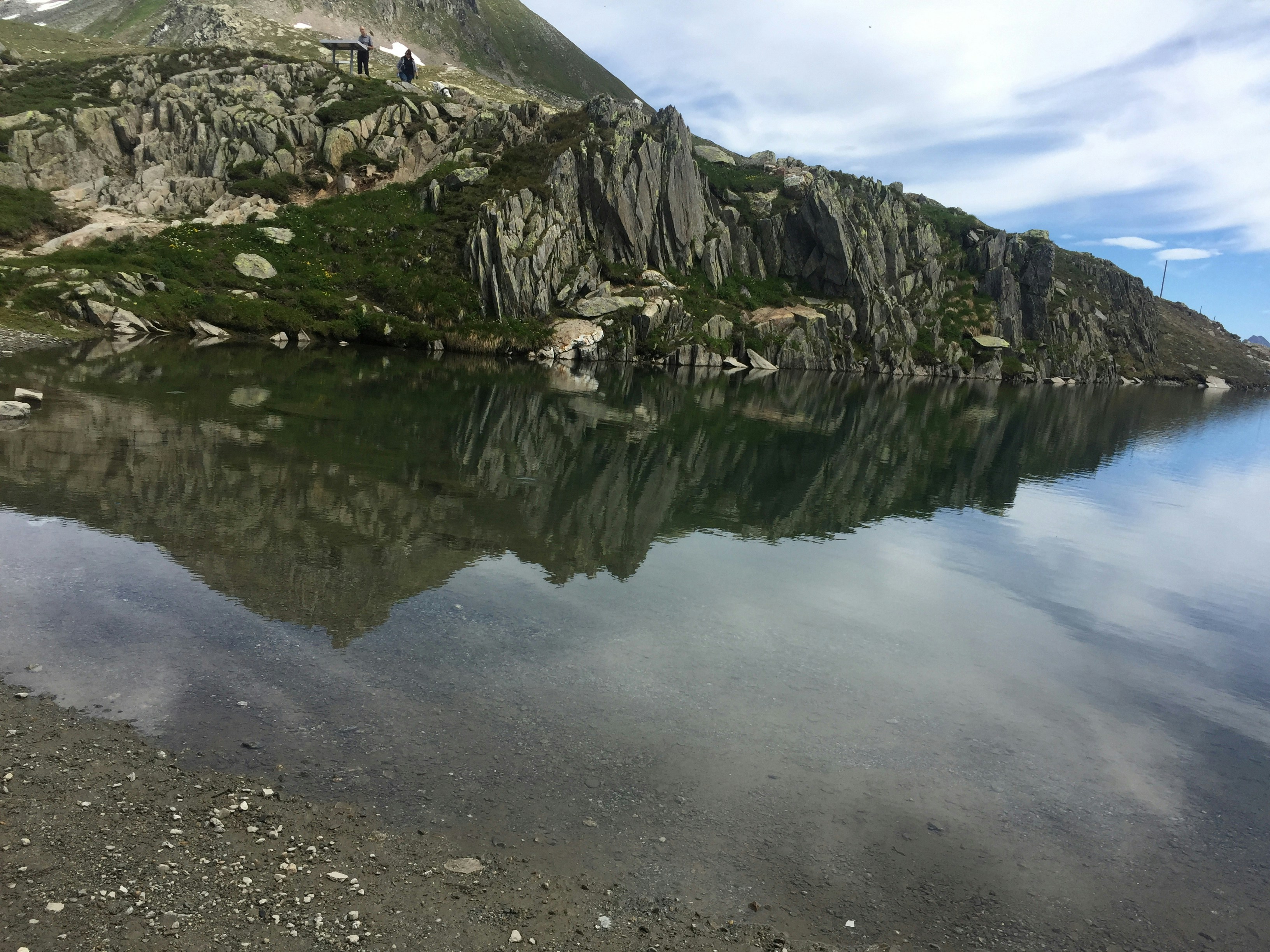 a mountain is reflected in the still water of a lake