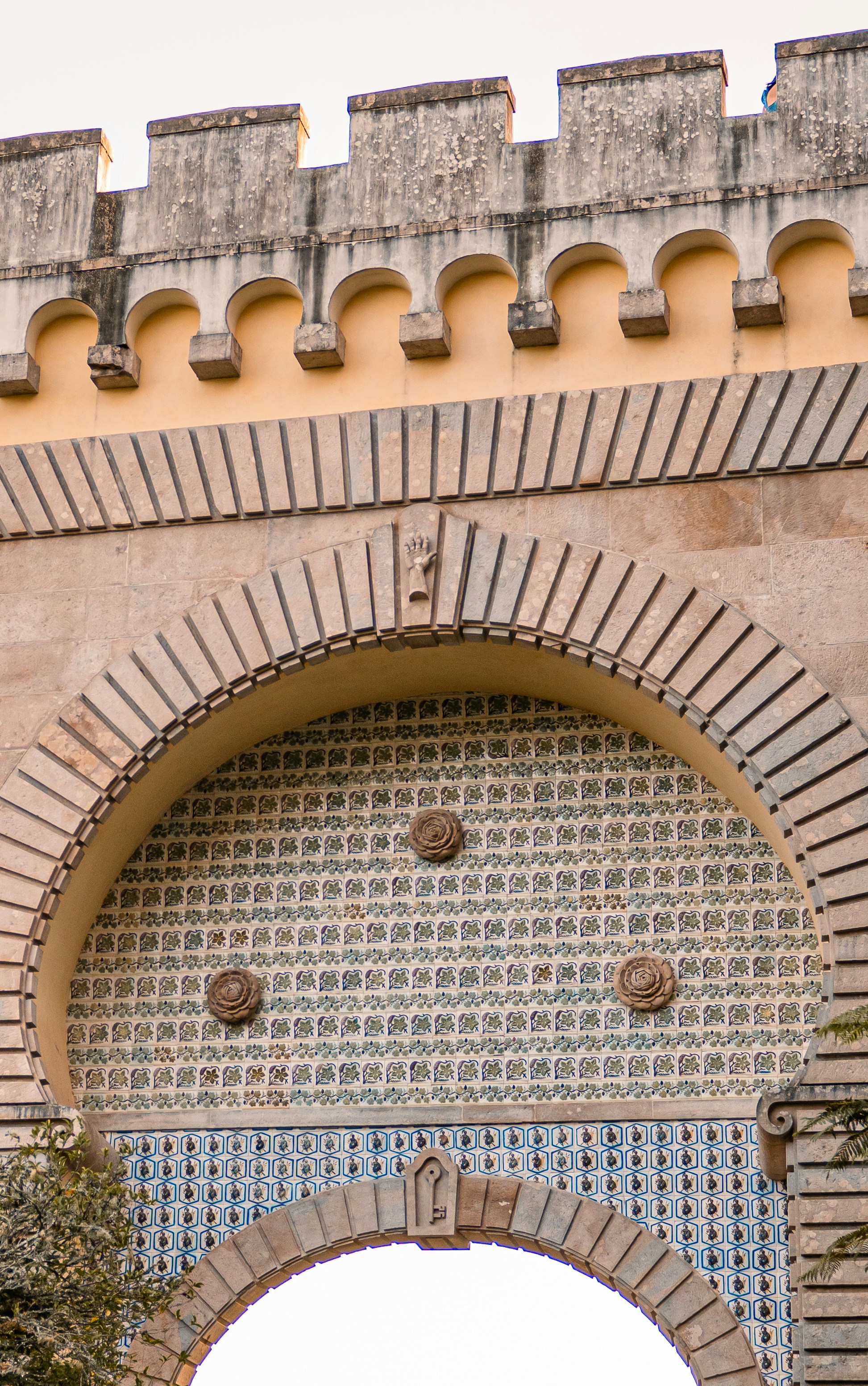 An arch in a wall with a clock on it photo – Free Sintra Image on Unsplash