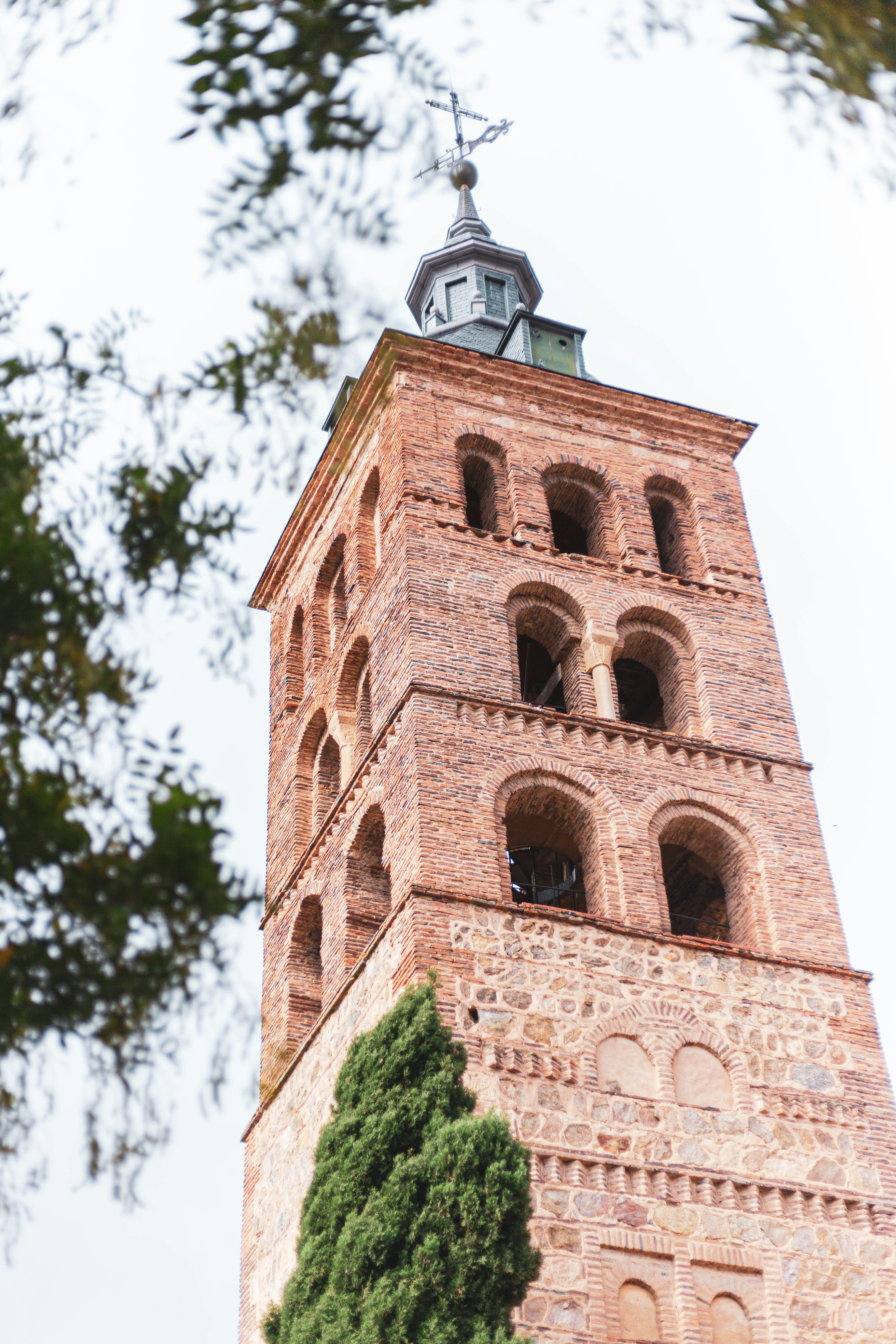 A tall brick tower with a clock on top photo – Free Bell tower Image on ...