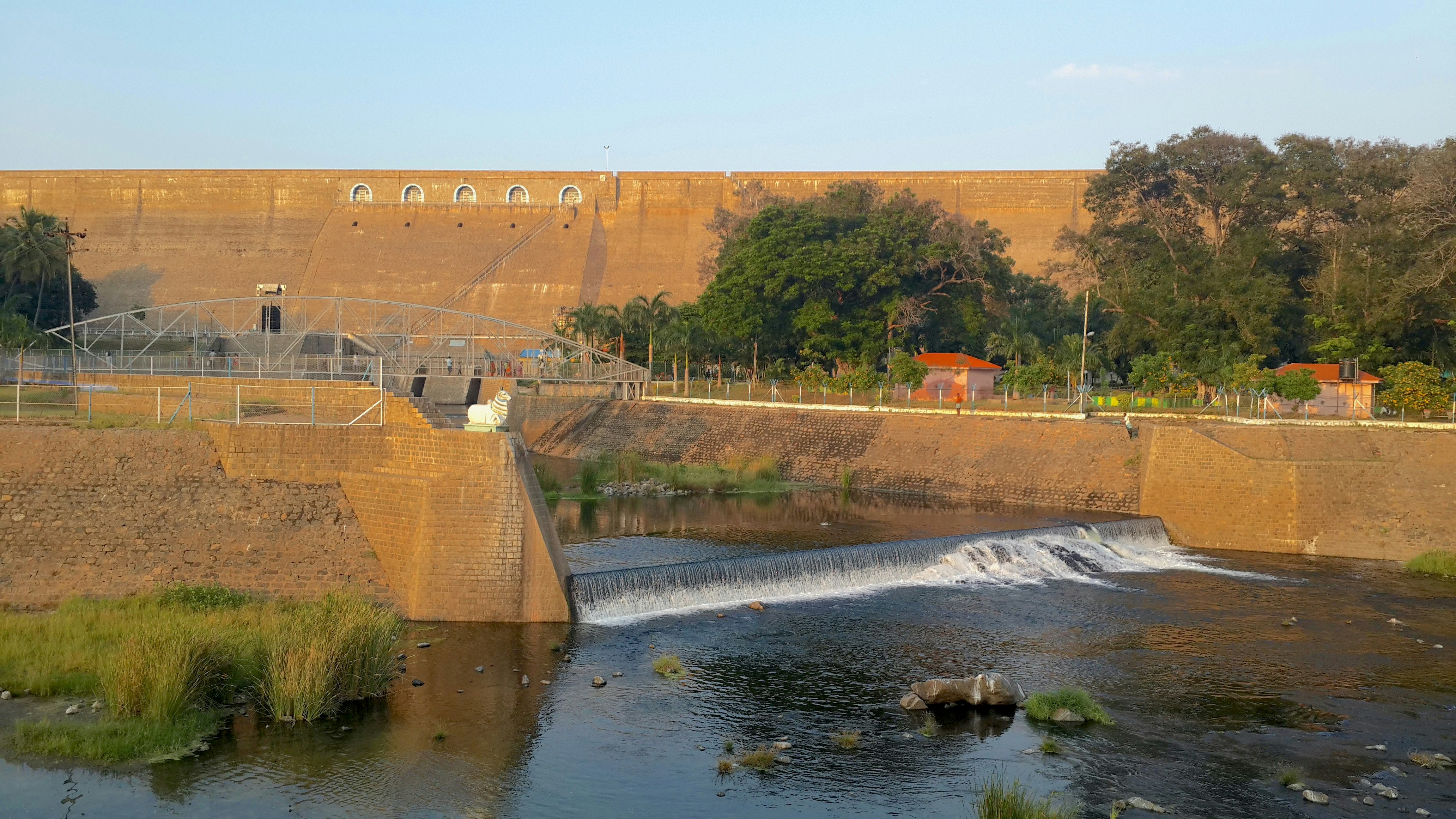 A river running through a city next to a tall brick building photo ...