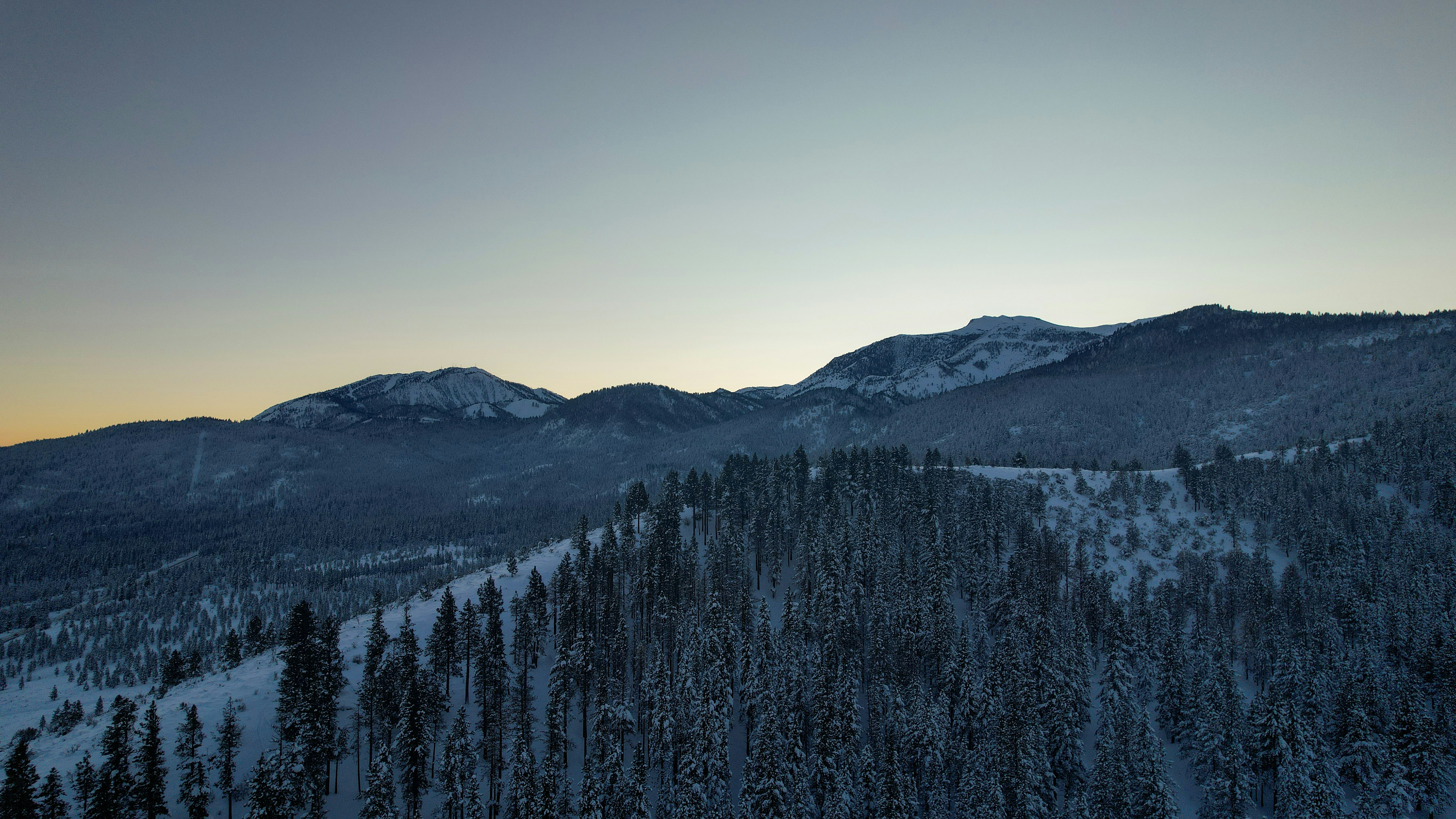 A view of a snowy mountain range at sunset photo – Free Reno Image on ...