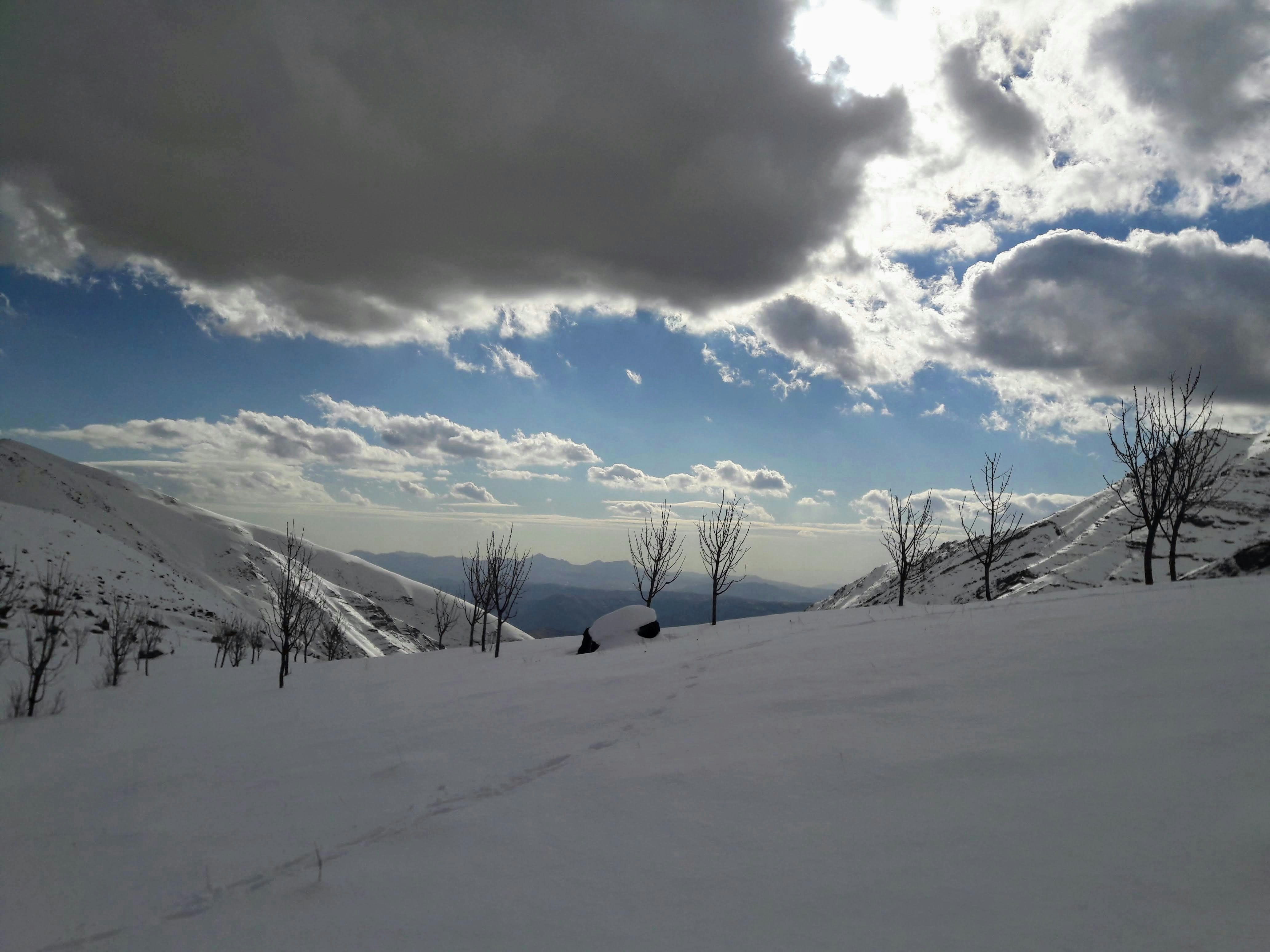 Snowbound Ridge Beneath Breaking Clouds