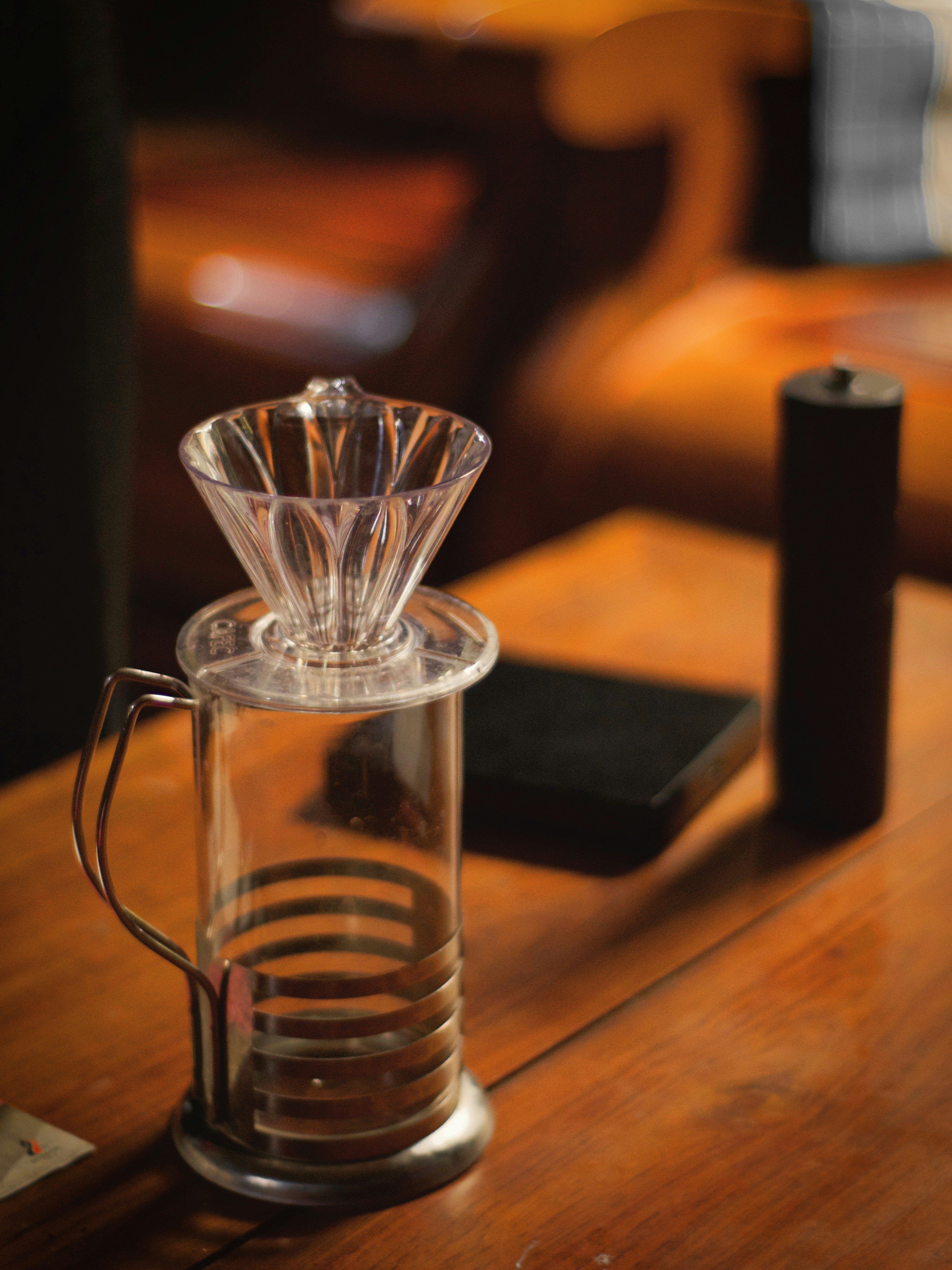A glass coffee pot sitting on top of a wooden table photo – Free ...