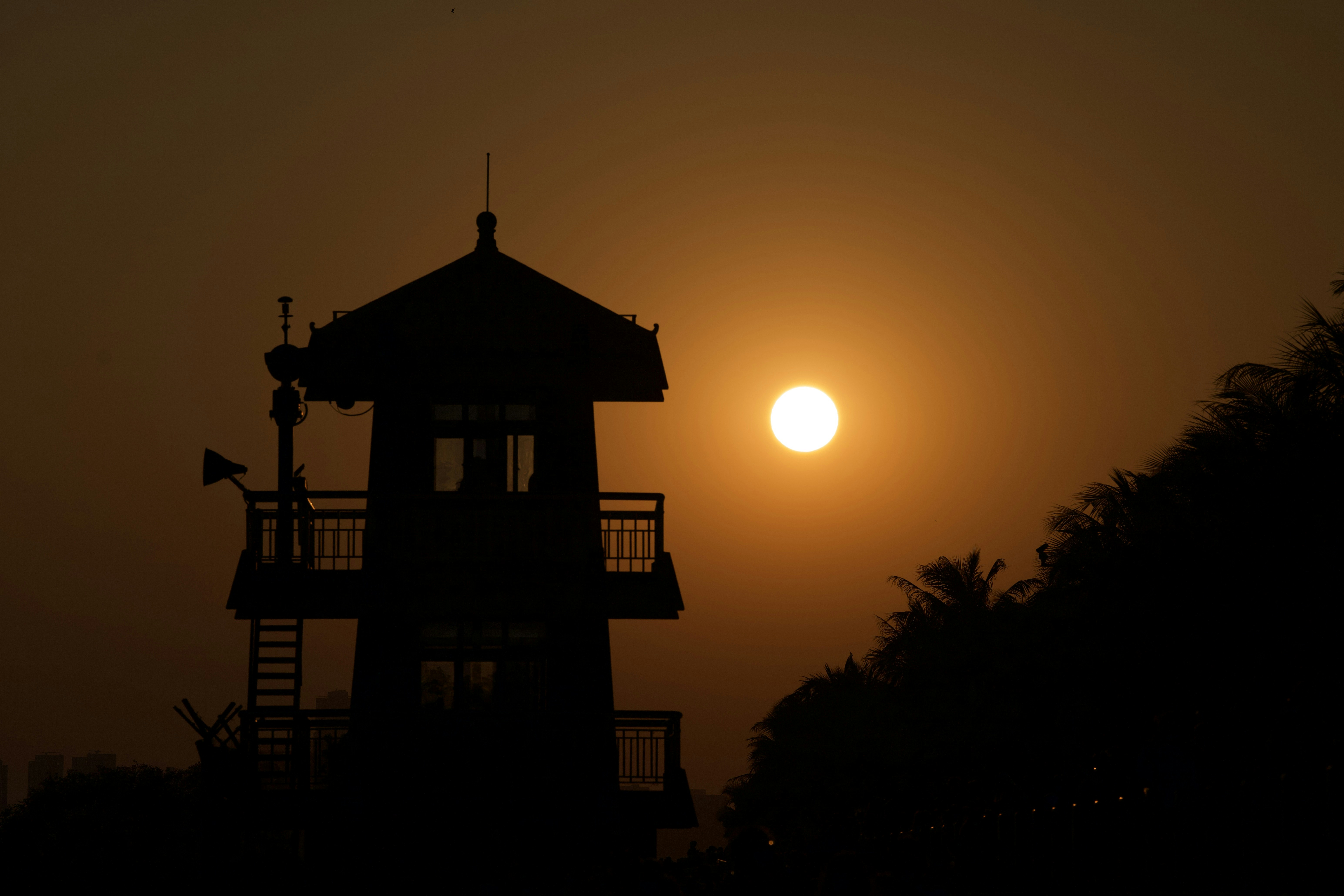 The sun is setting behind a lighthouse tower photo – Free 深圳市 Image on ...
